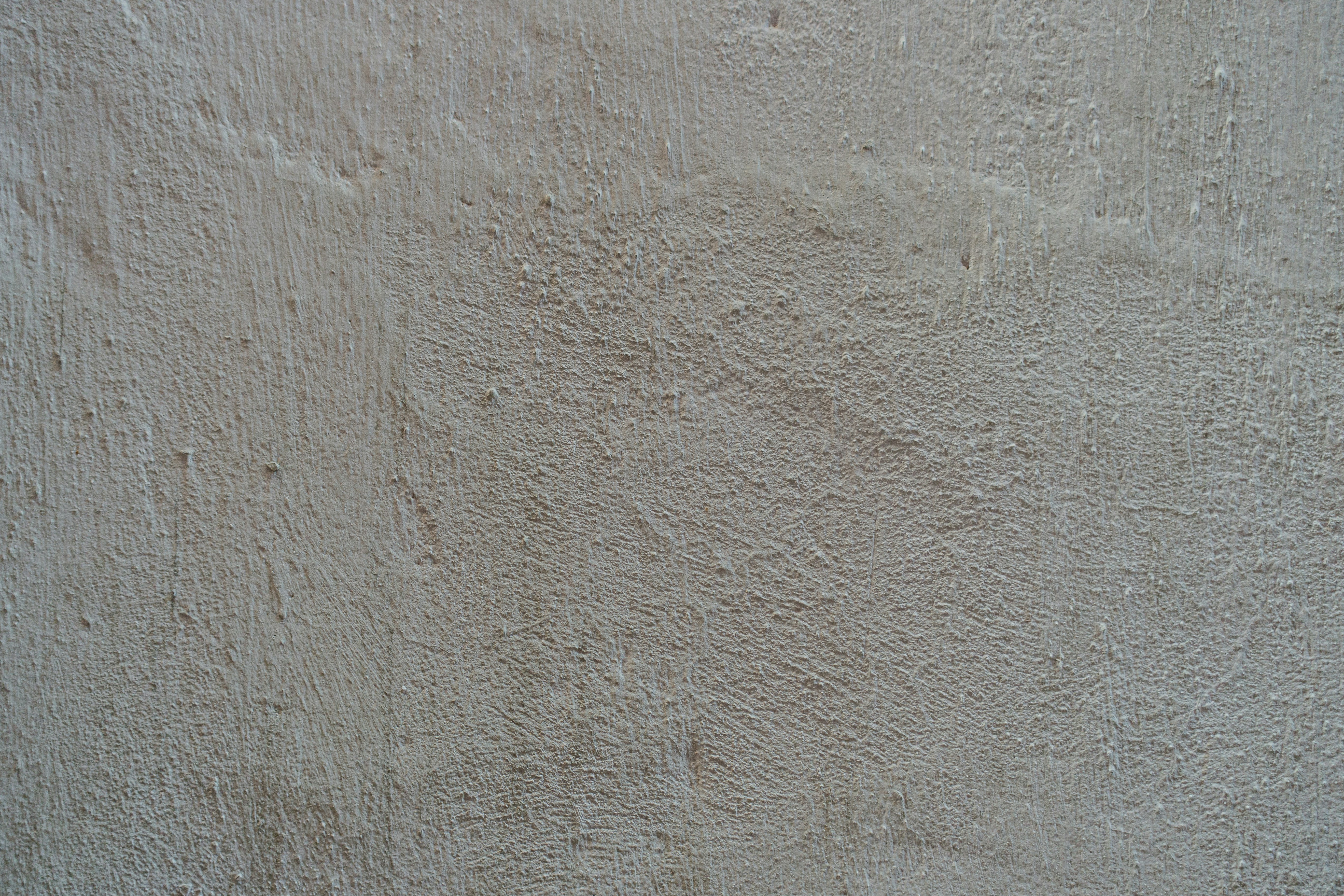 A red fire hydrant sitting on the side of a building photo – Texture ...