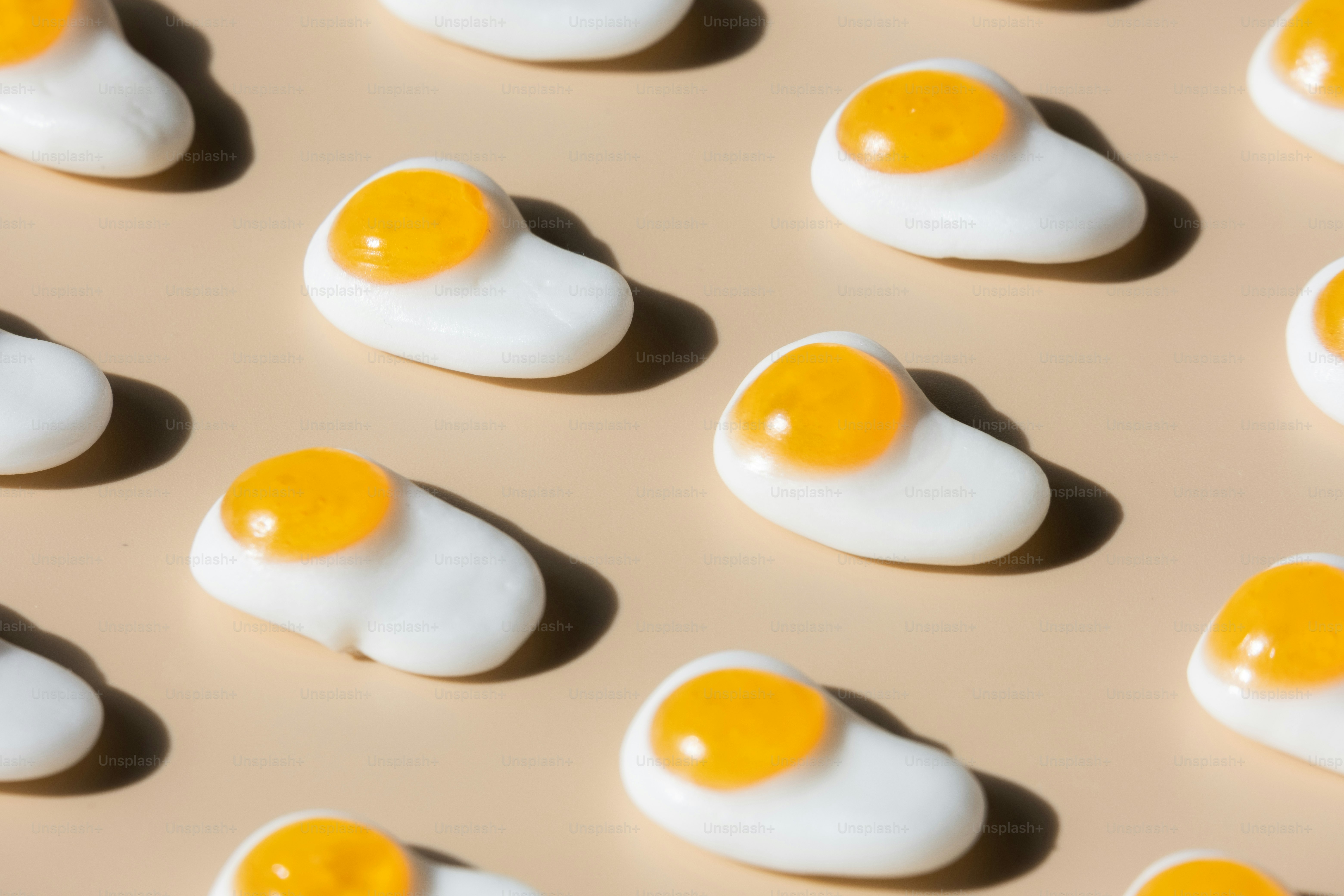 A group of eggs sitting on top of each other photo – Fried egg Image on ...