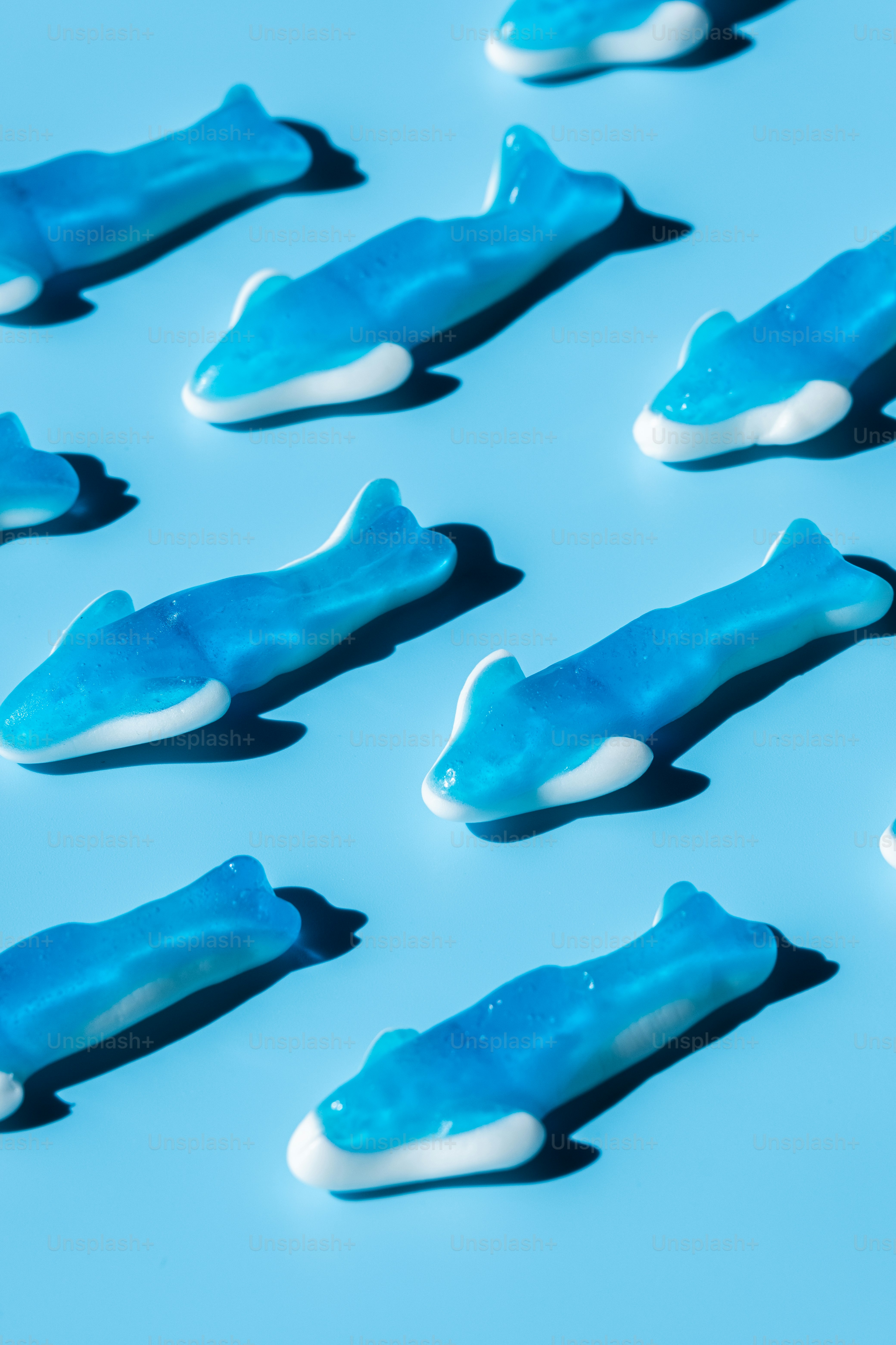 A group of blue and white candies on a blue surface photo – Blue food ...