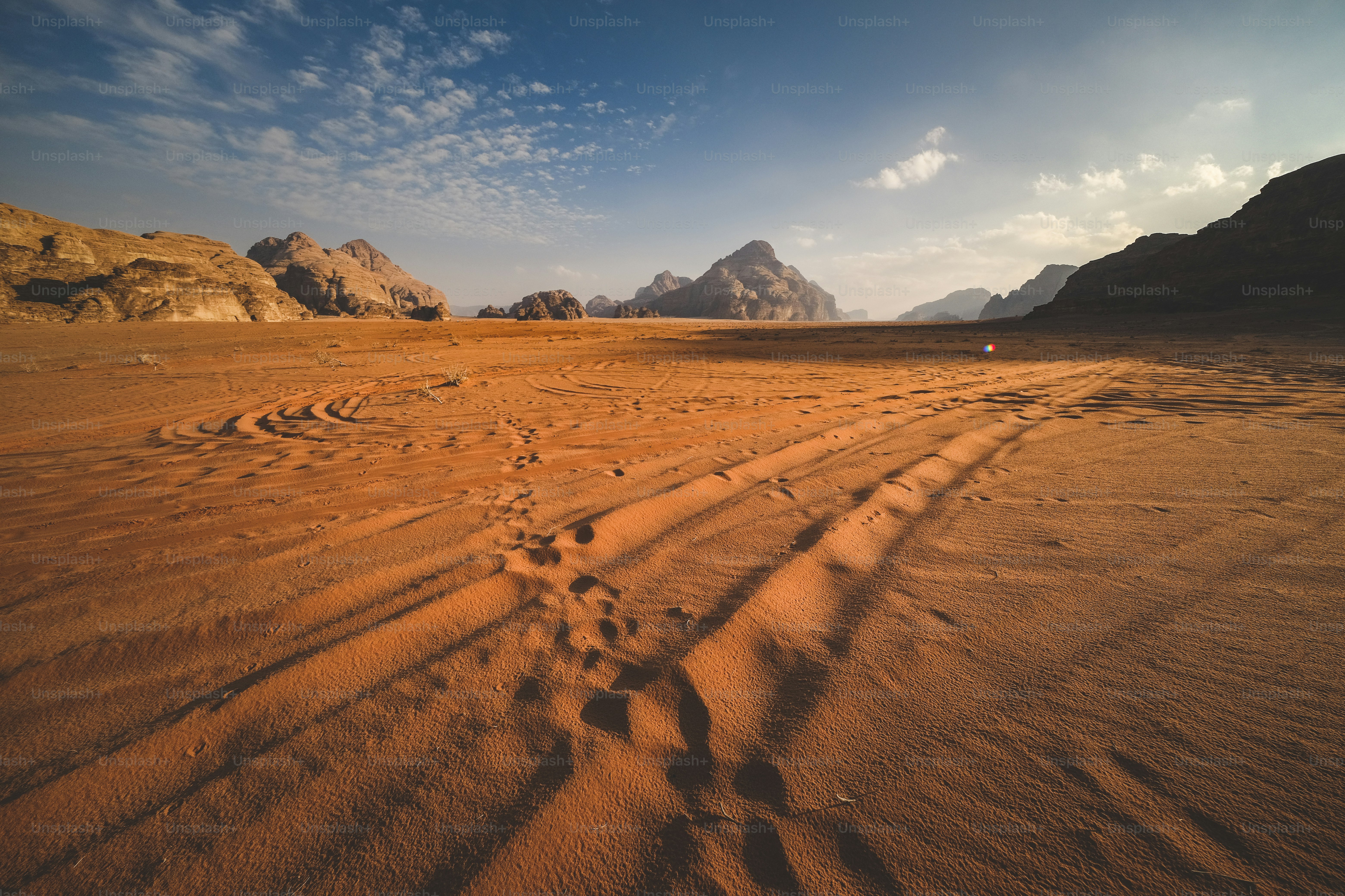 A sandy area with mountains in the background photo – Desert Image on ...