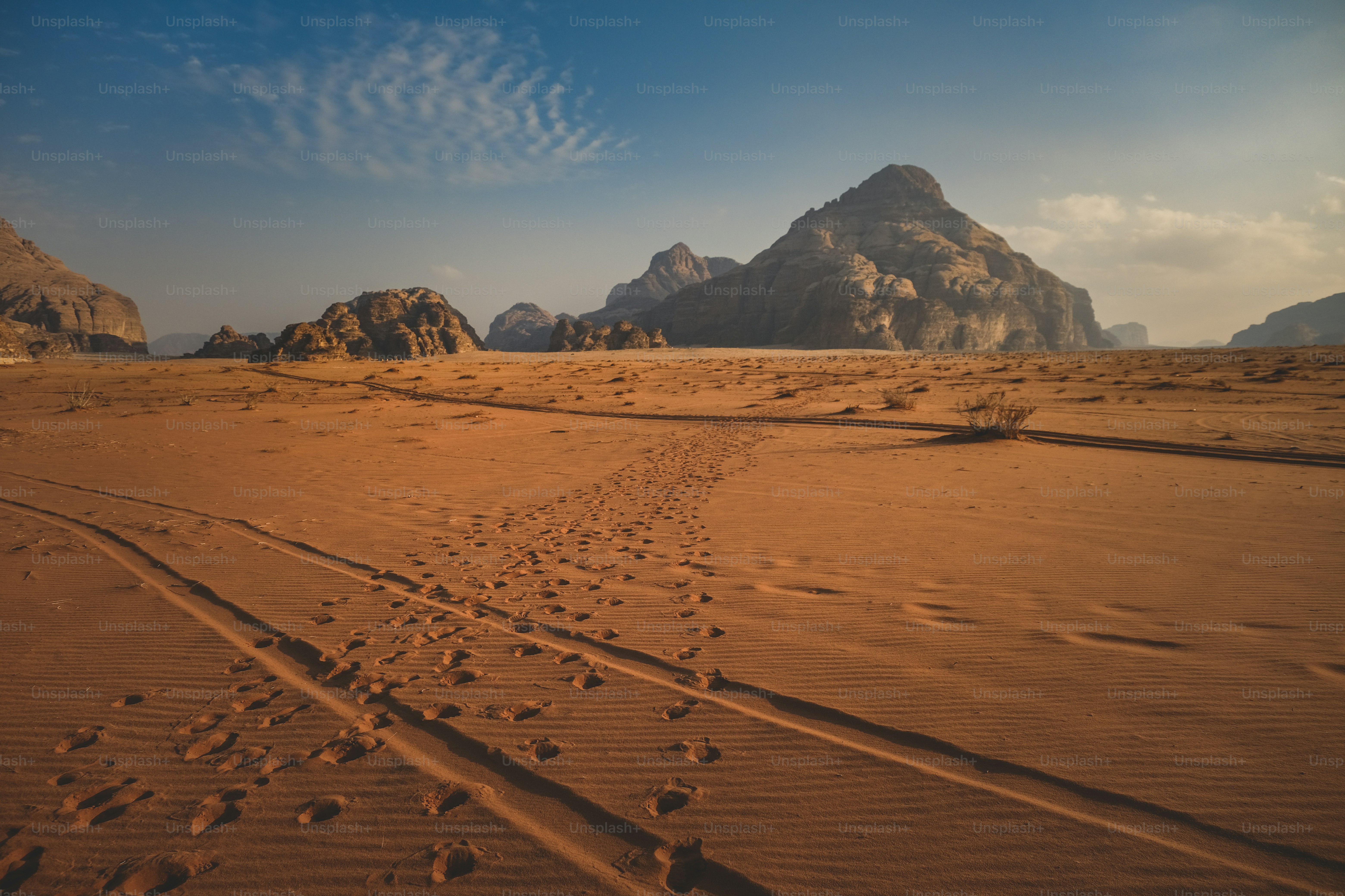 A trail of footprints in the desert at sunset photo – Desert Image on ...