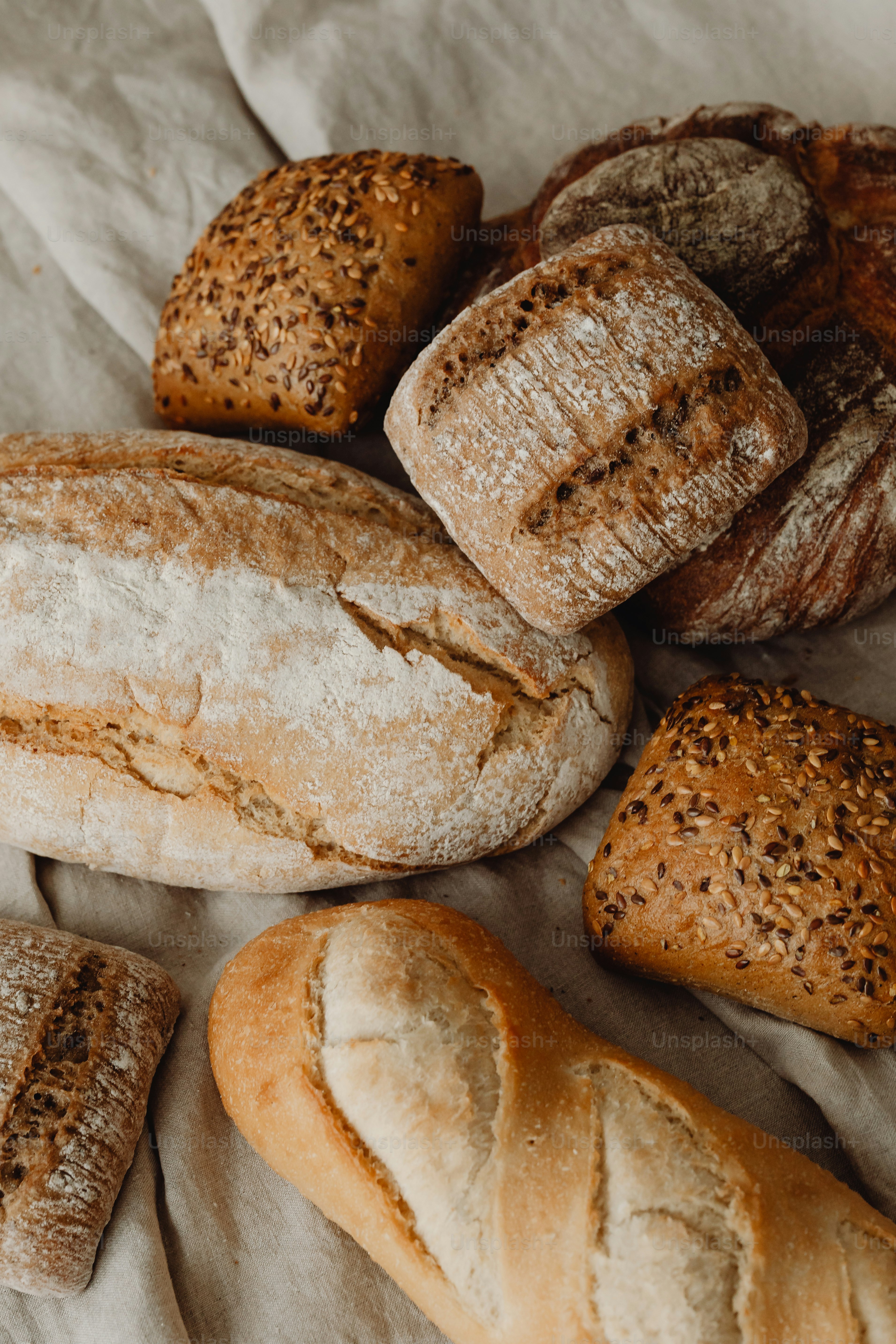 A bunch of different types of bread on a table photo – Food Image on ...
