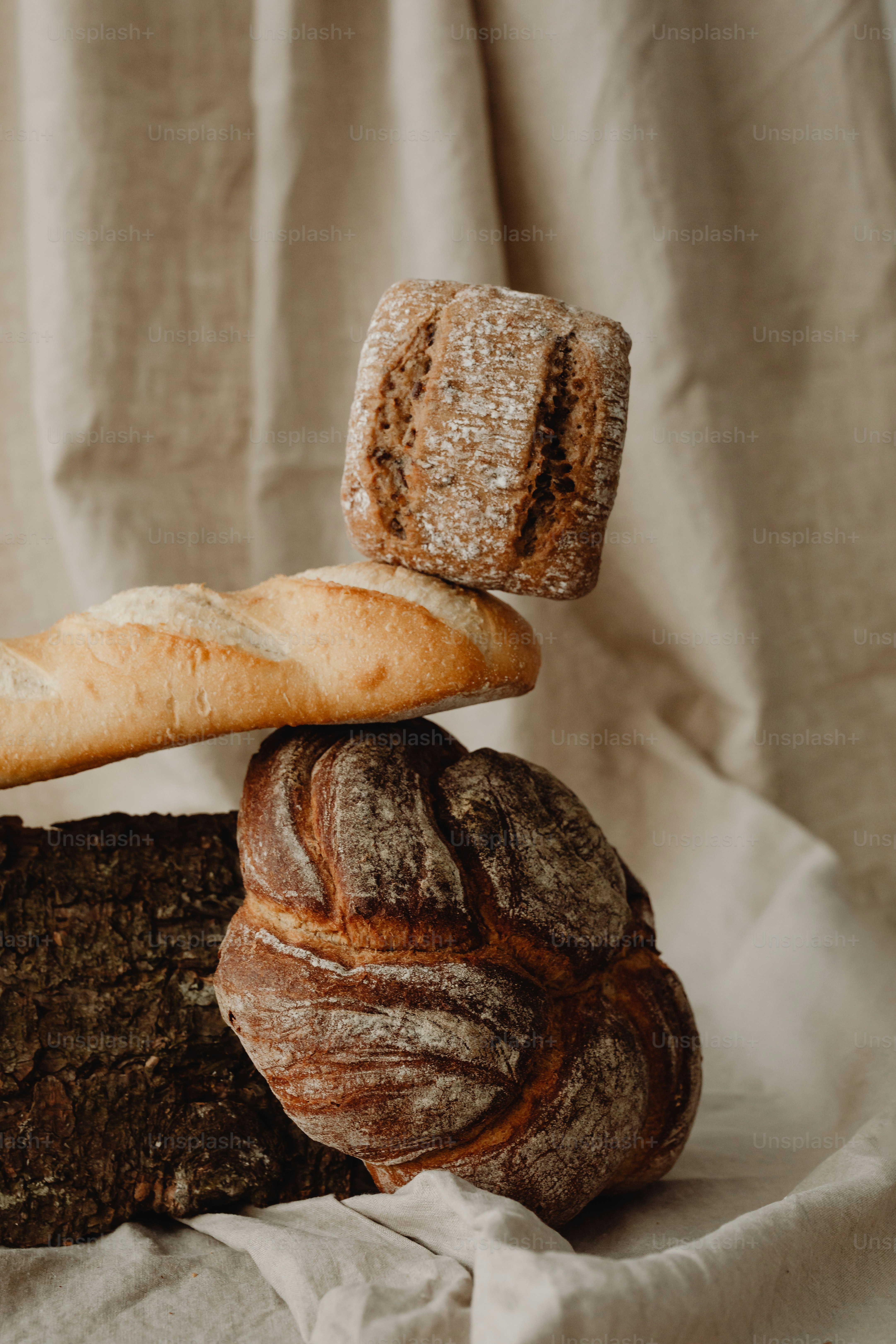 A bunch of breads stacked on top of each other photo – Bakery Image on ...