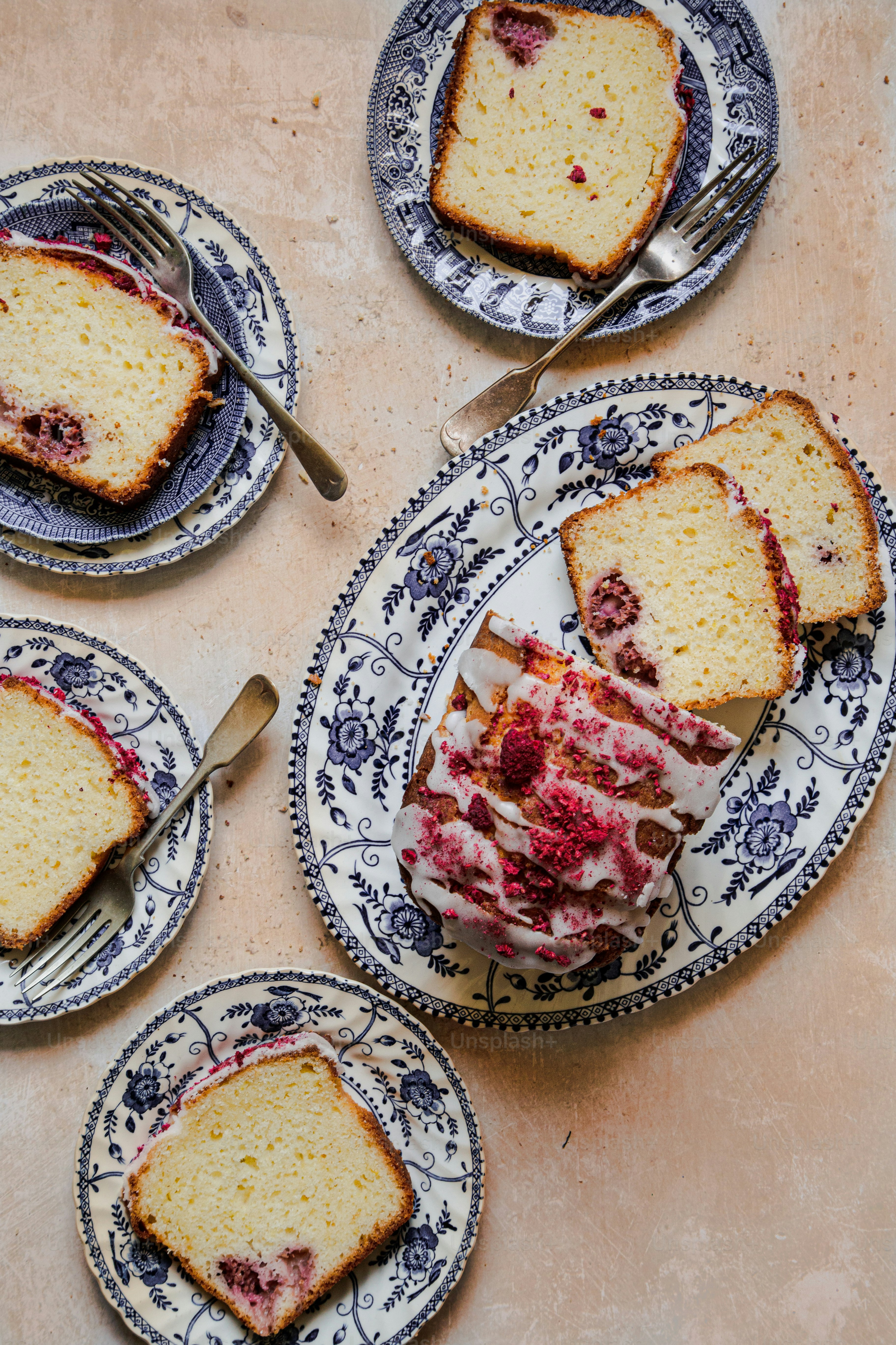 A table topped with blue and white plates filled with cake photo ...