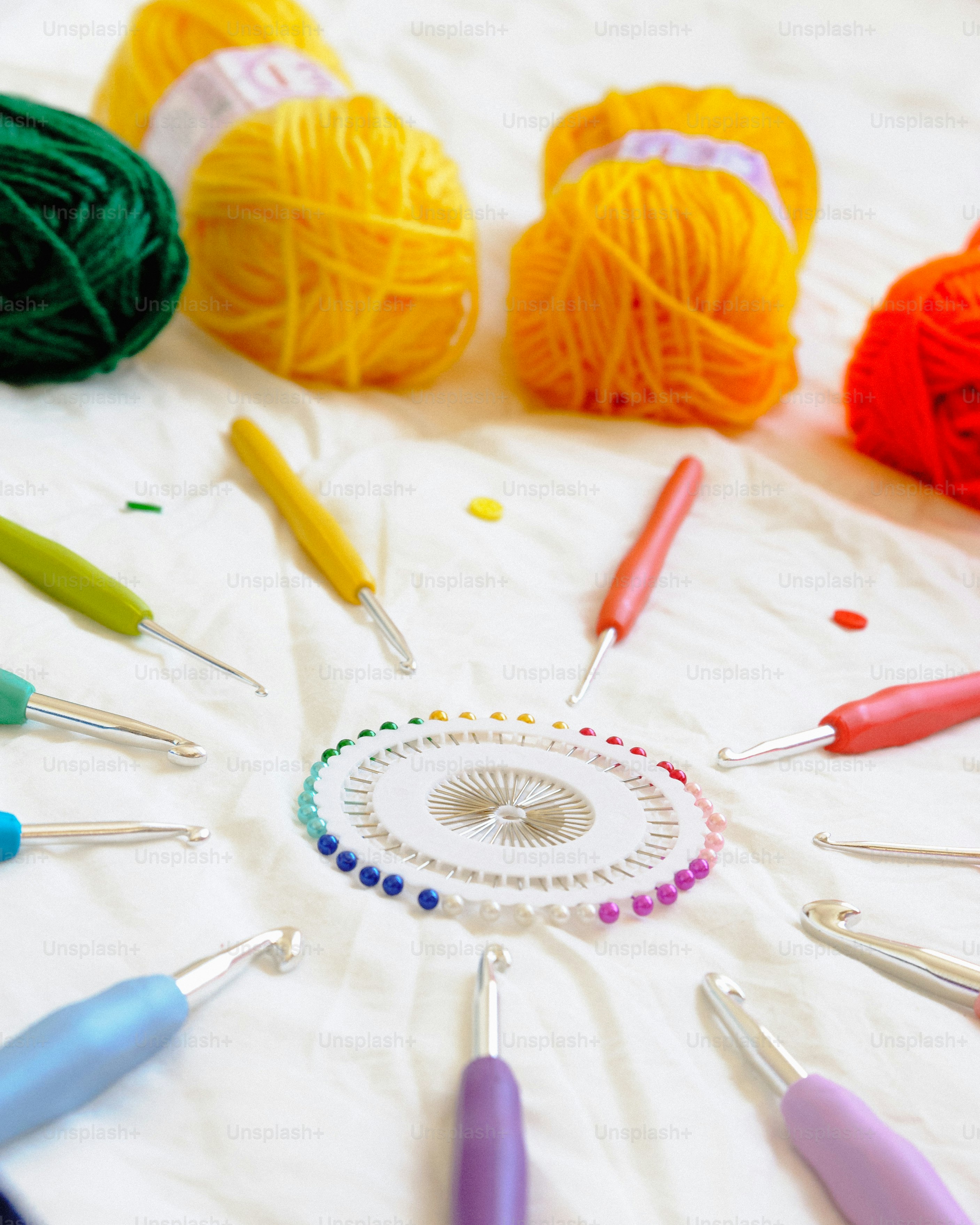 A group of balls of yarn sitting on top of a bed photo – Crochet Image ...