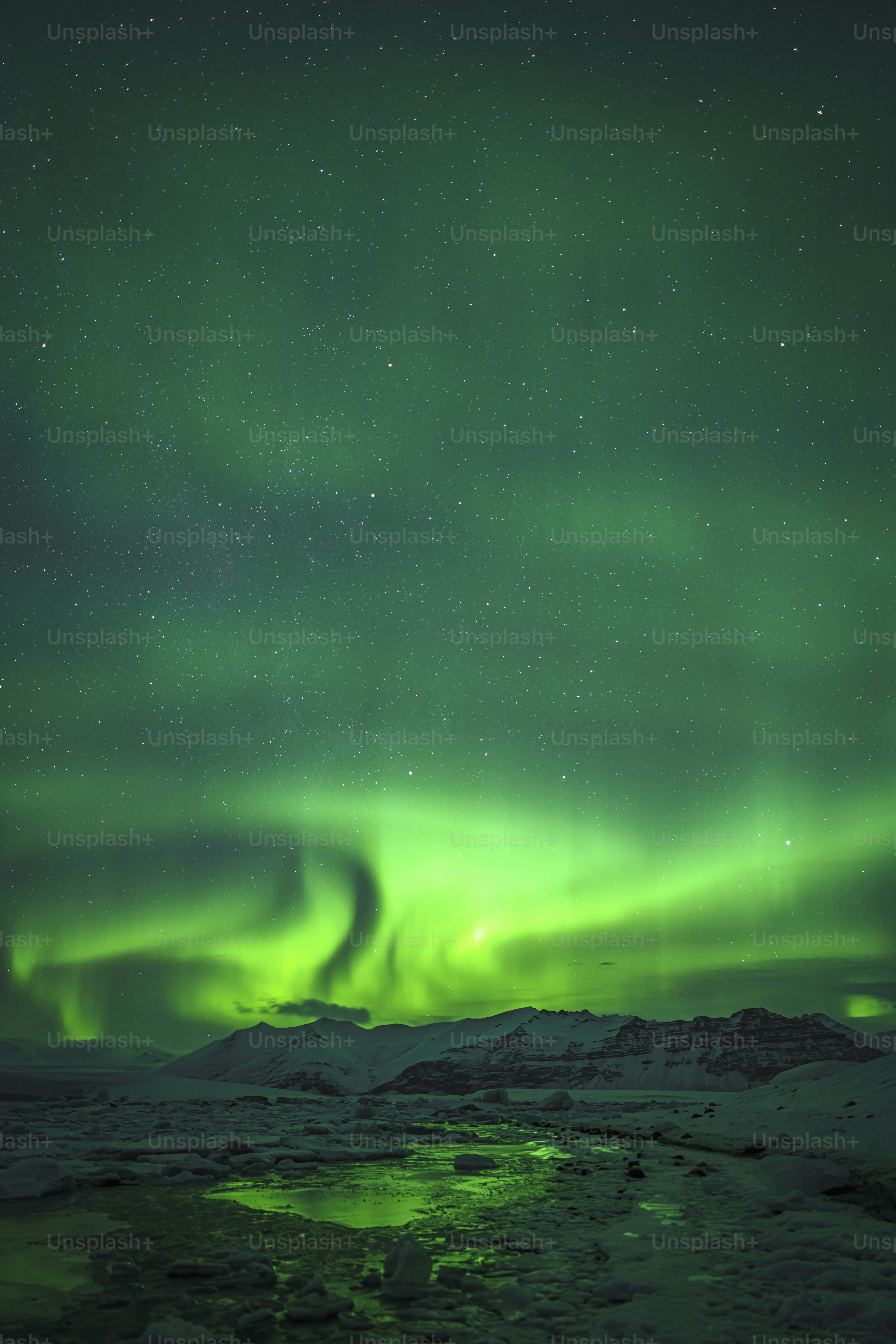 A green and purple aurora bore is in the sky photo – Landscape Image on ...