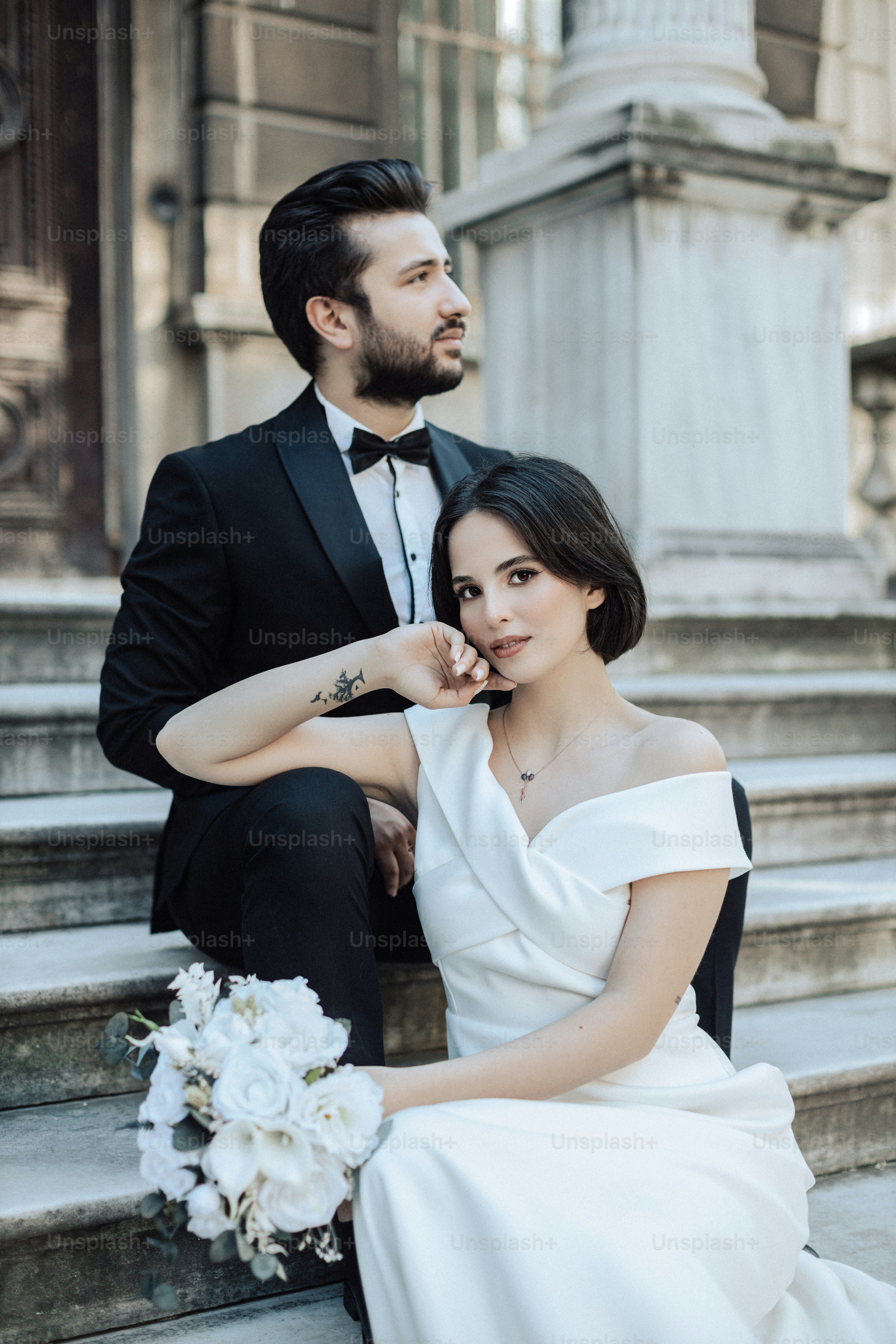 A bride and groom standing on a staircase photo – Wedding photography ...