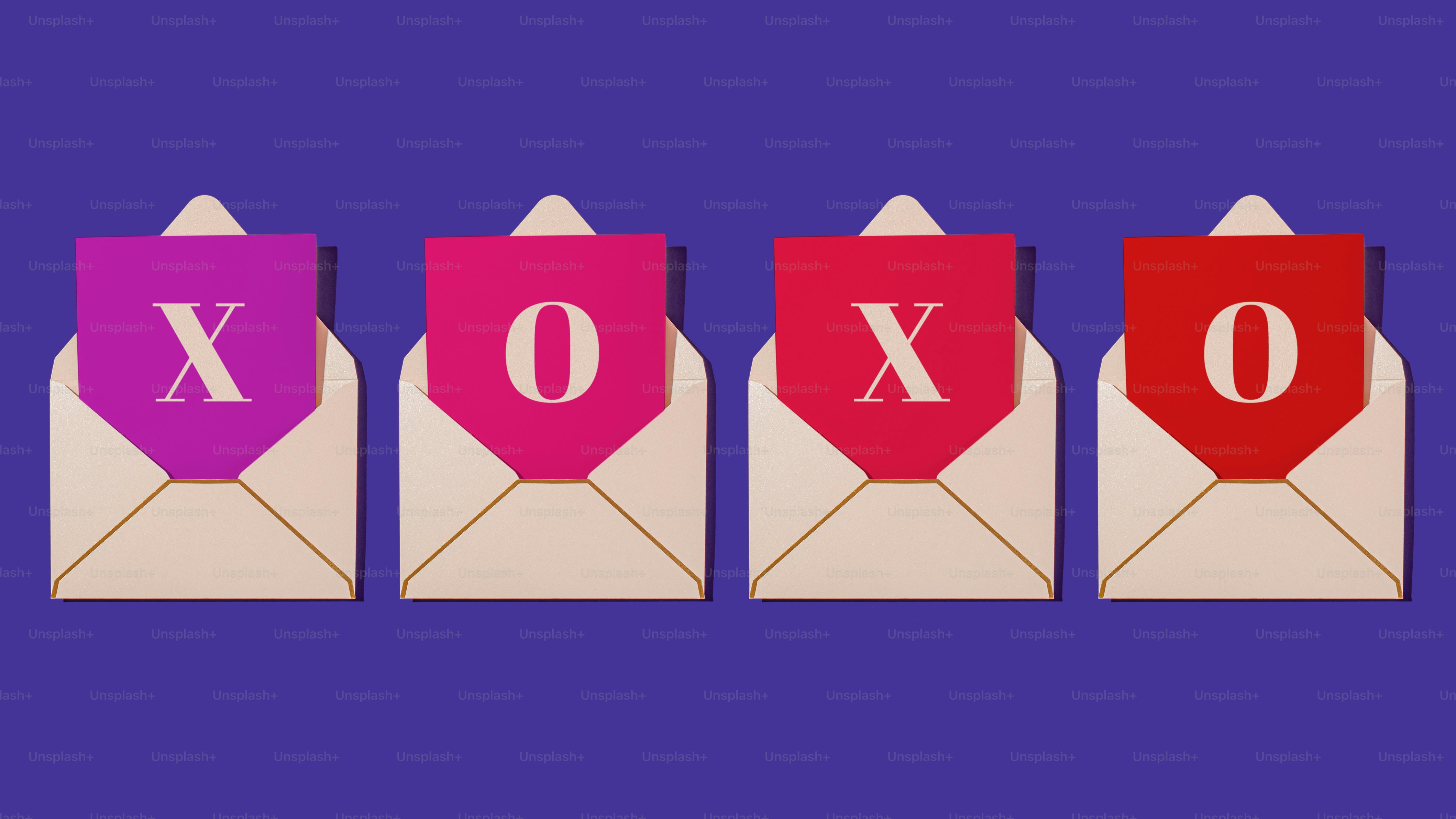 A set of three envelopes with the word xoxo printed on them photo ...