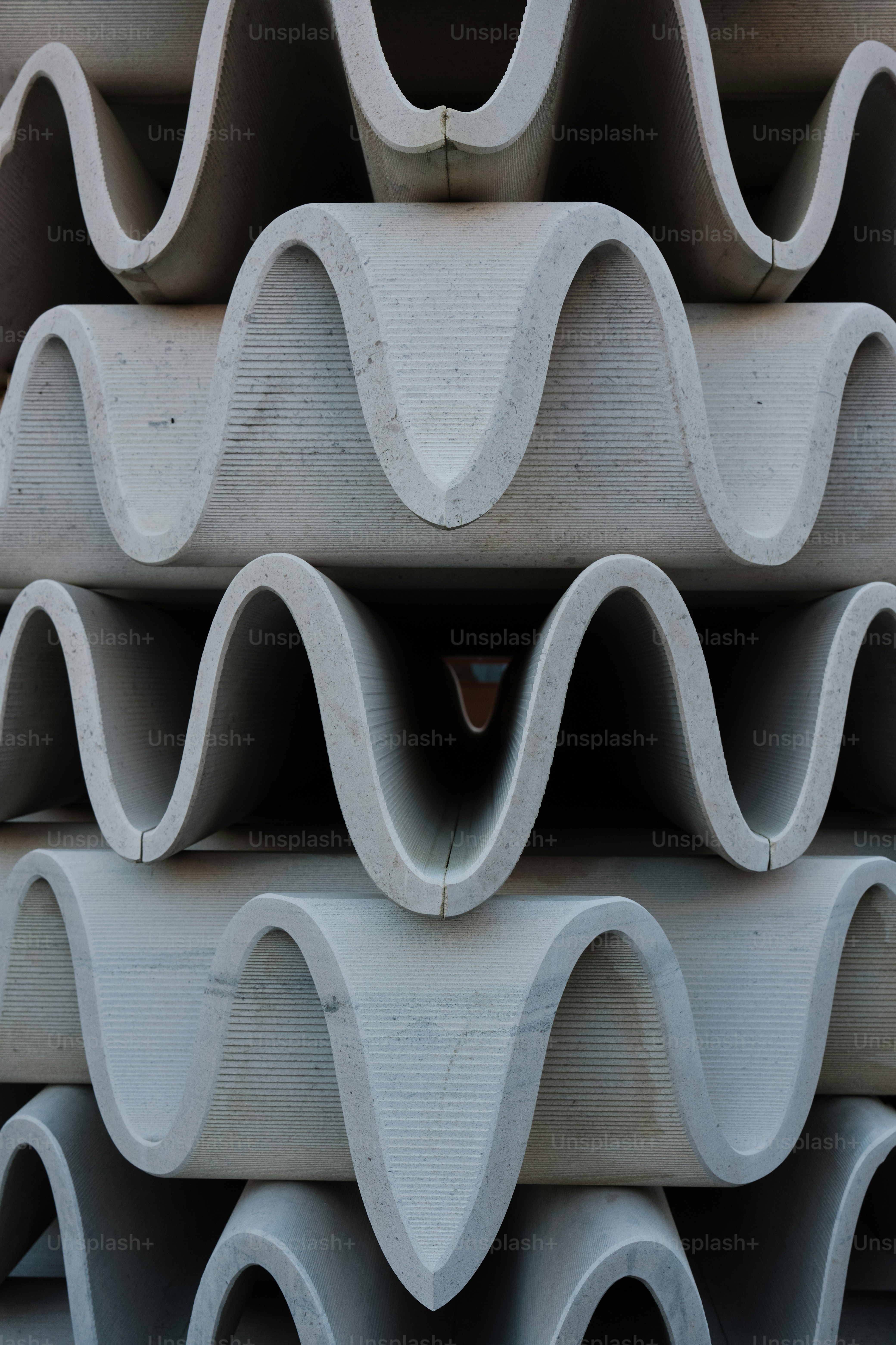 A stack of cement pipes stacked on top of each other photo – Concrete ...