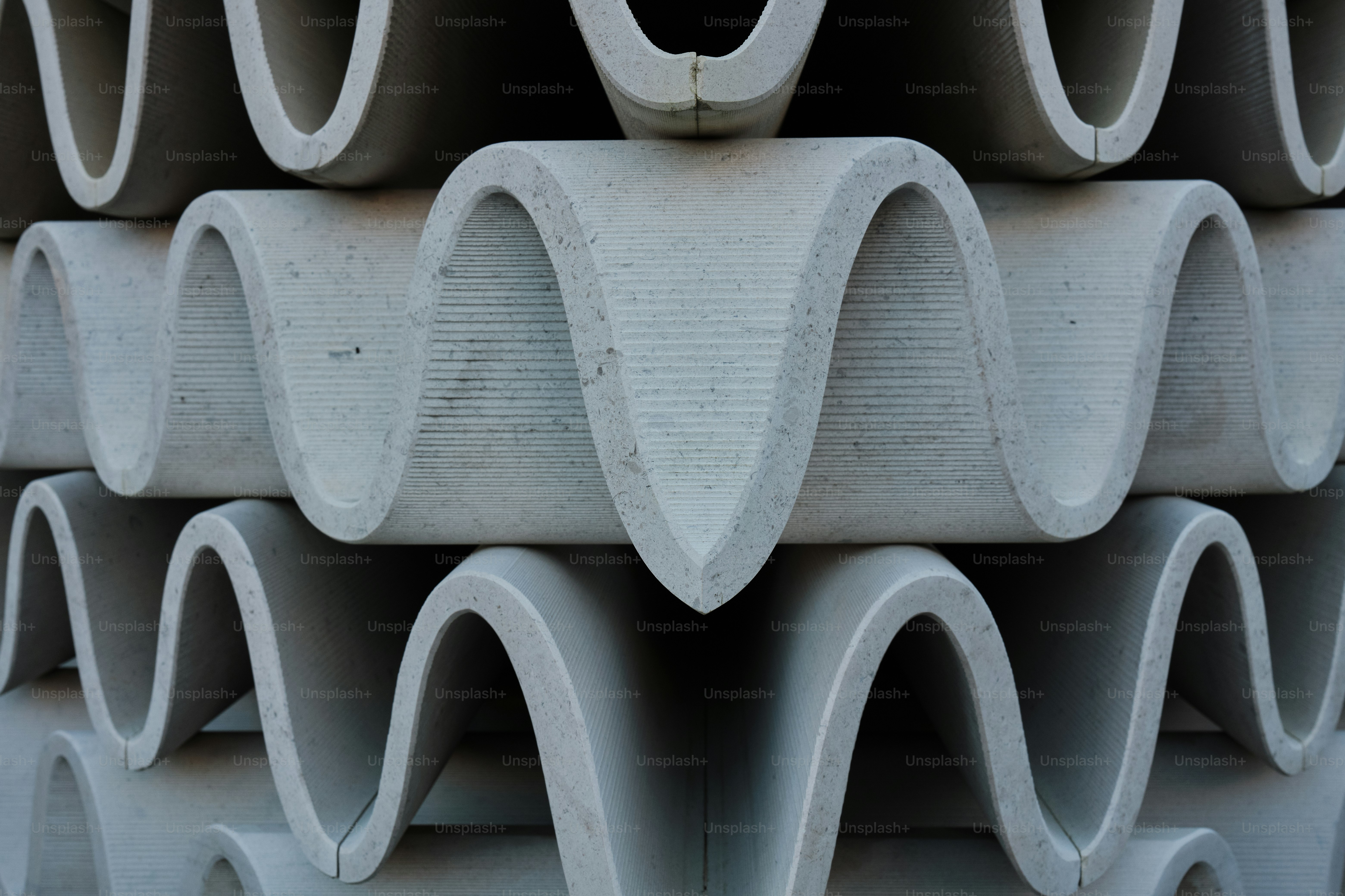 A stack of cement pipes stacked on top of each other photo – Concrete ...