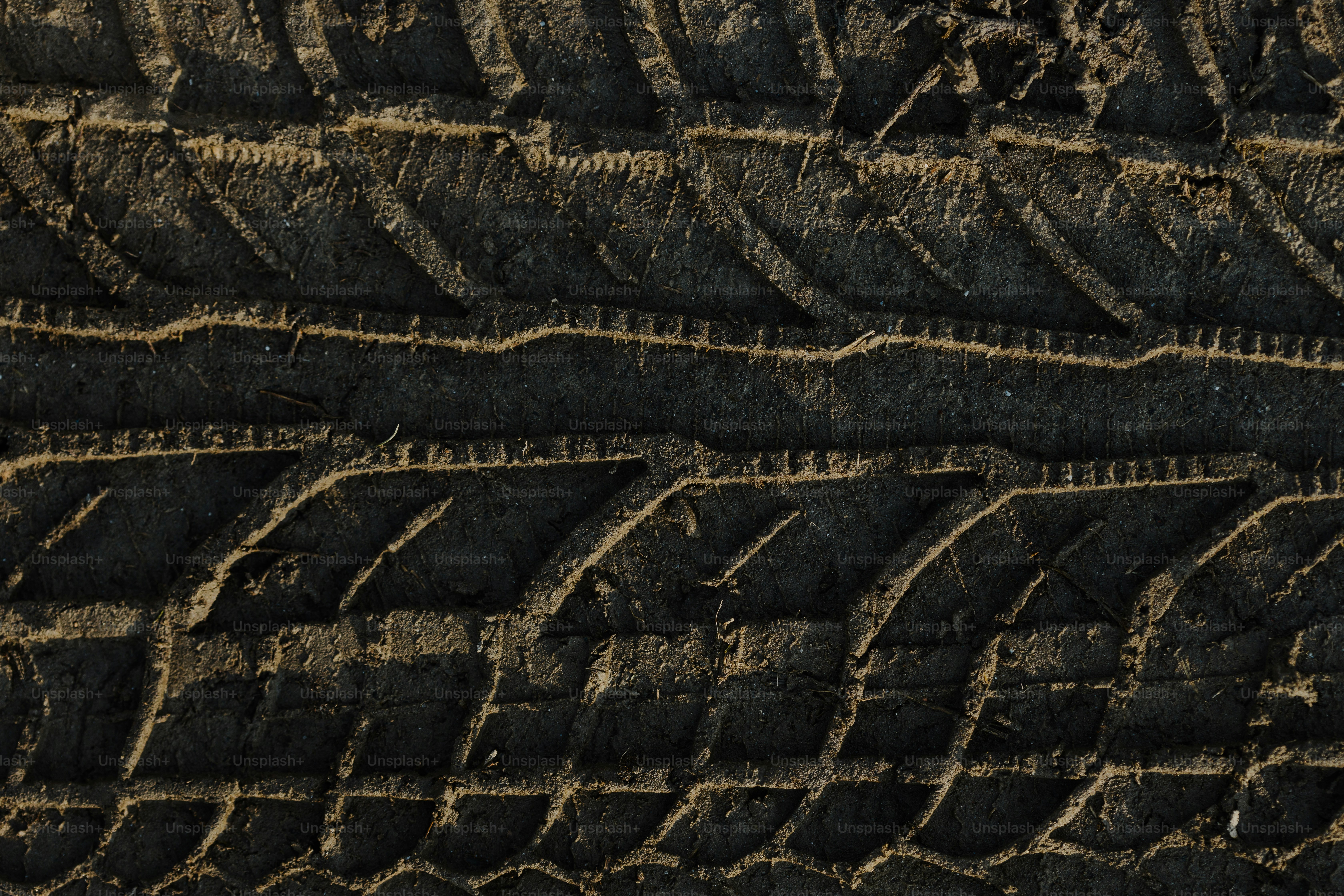 A close up of a tire on a dirt road photo – Texture Image on Unsplash