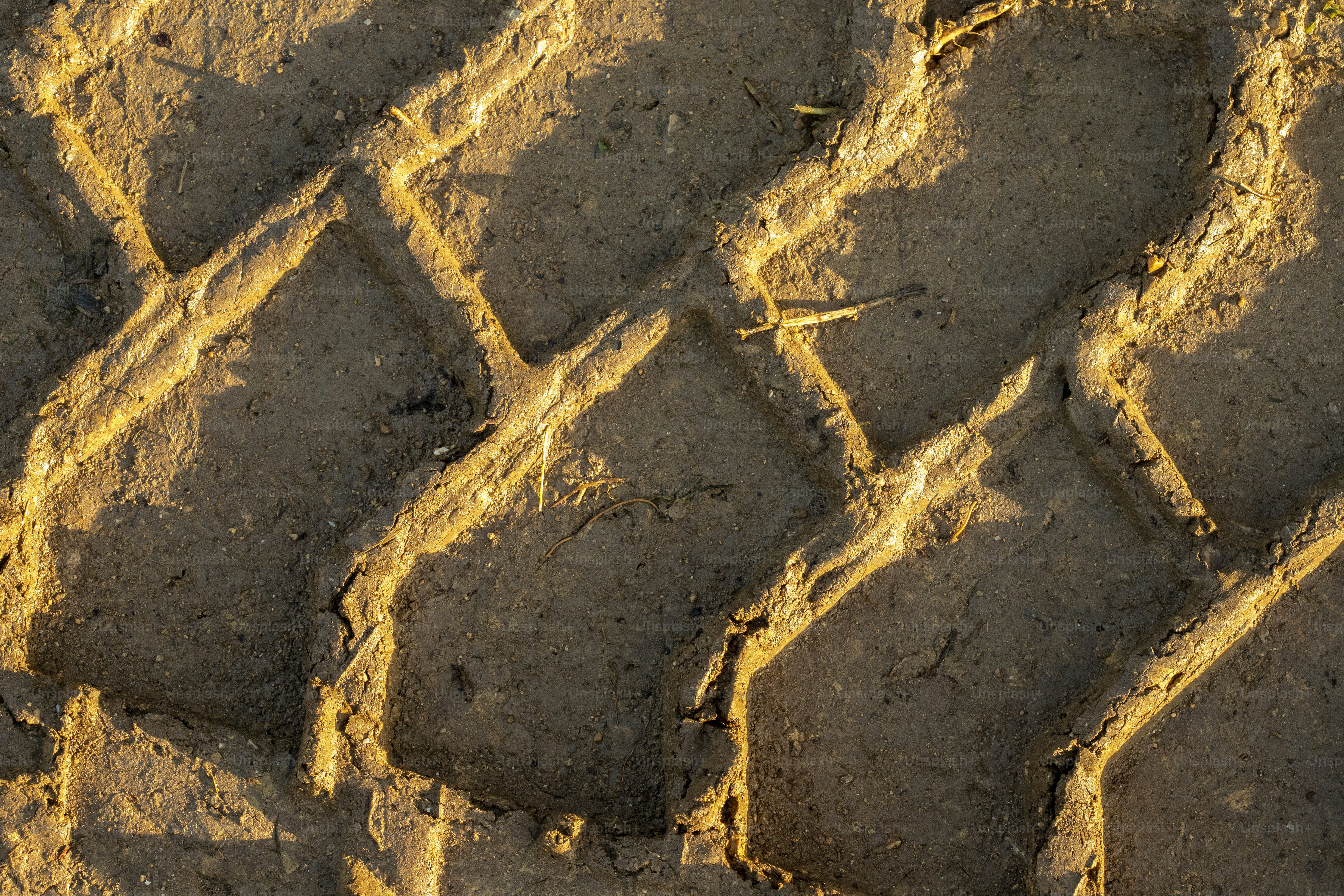 A close up of a brick pattern made of dirt photo – Sand Image on Unsplash