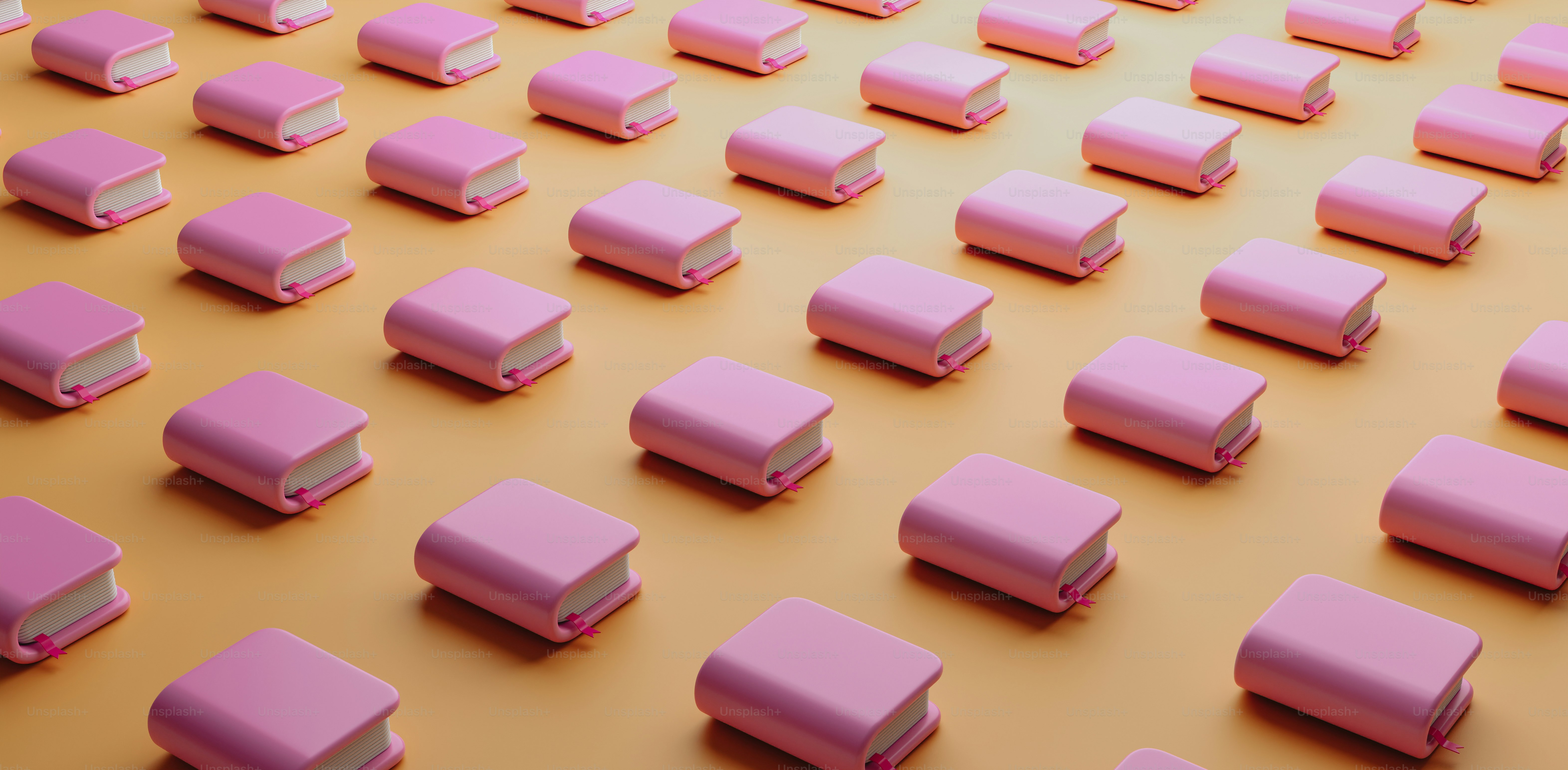A group of pink objects sitting on top of a yellow surface photo ...