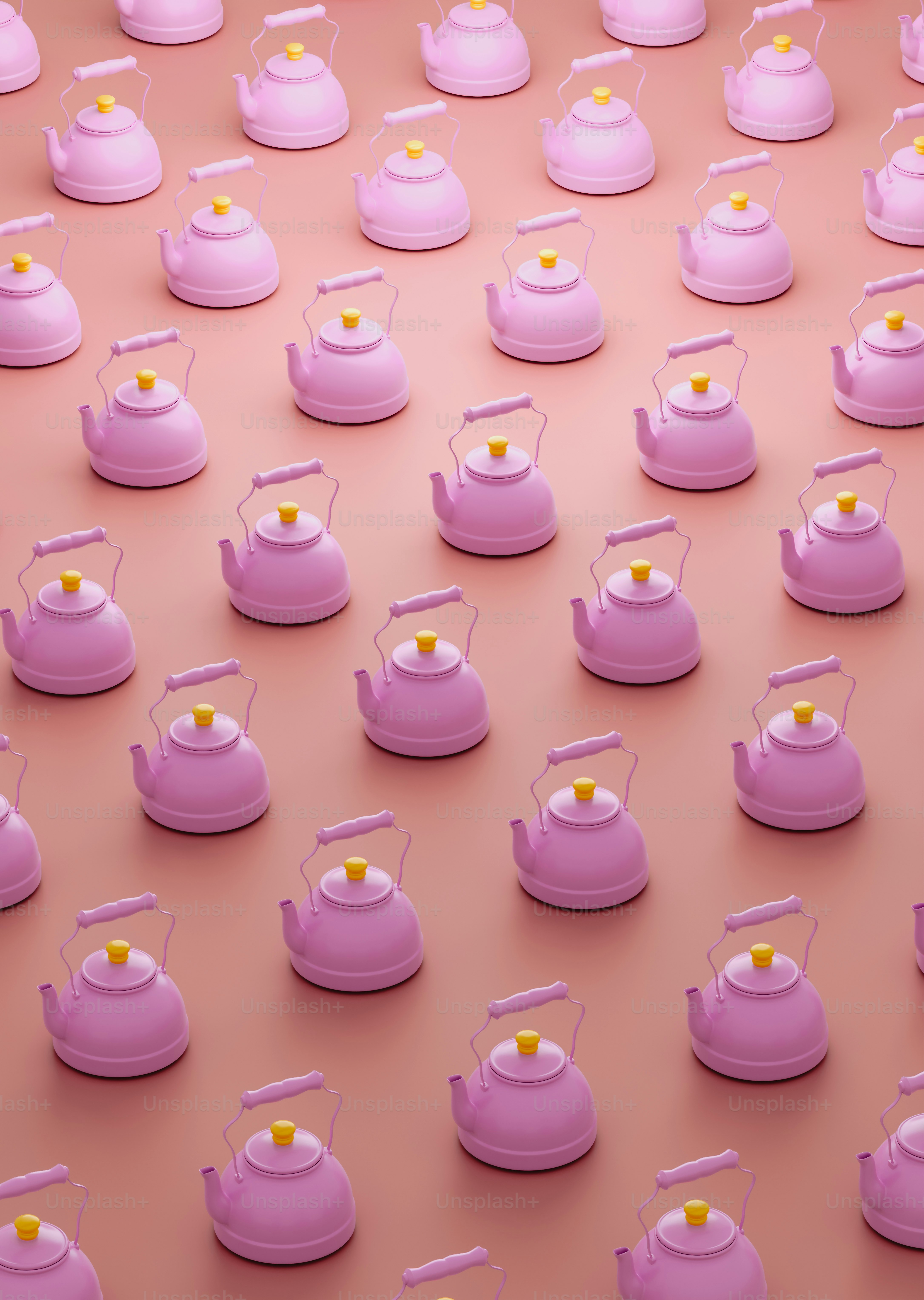 A group of pink tea kettles sitting on top of a pink surface photo ...