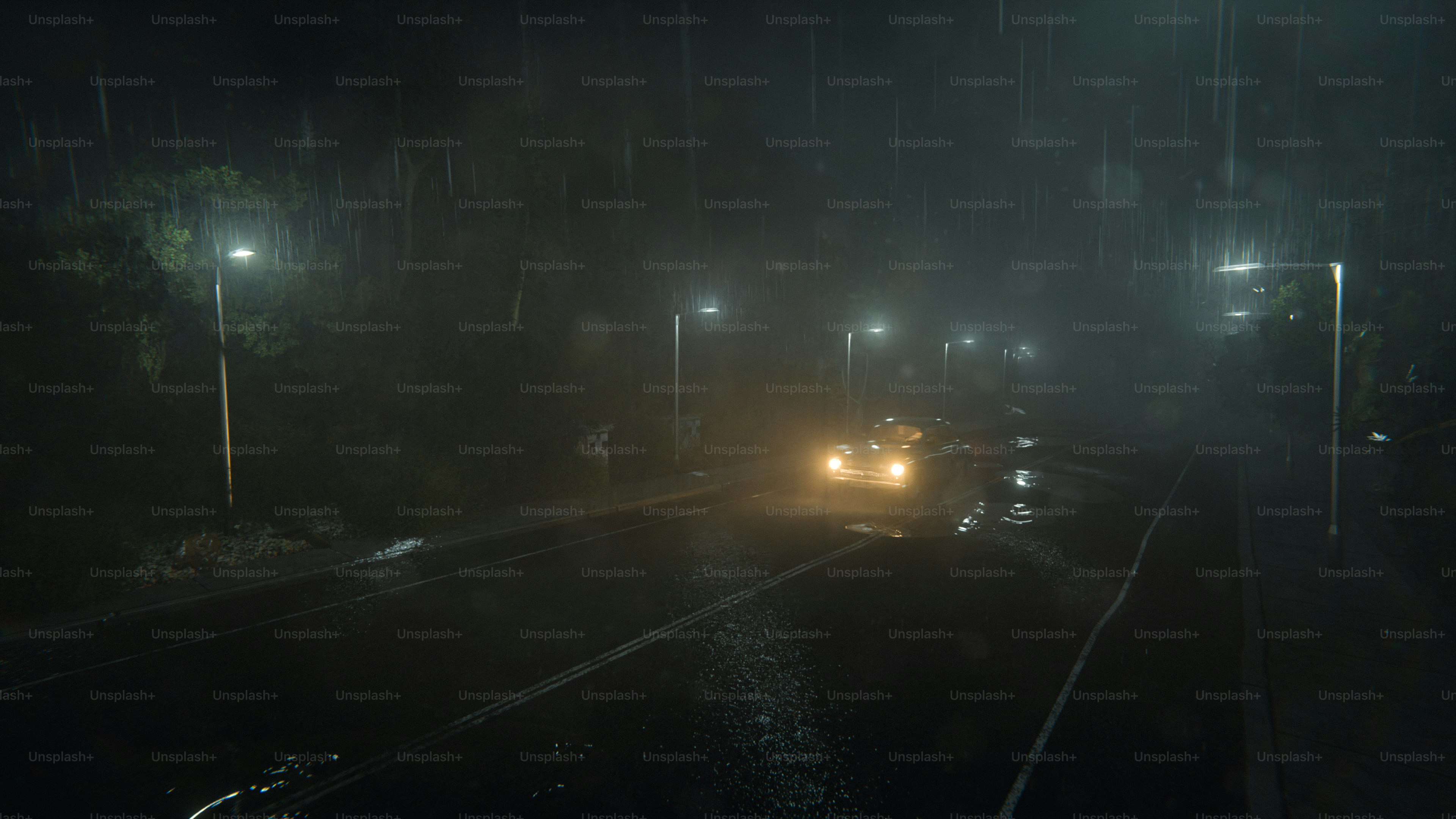 A car driving down a rain soaked road at night photo – Night Image on ...