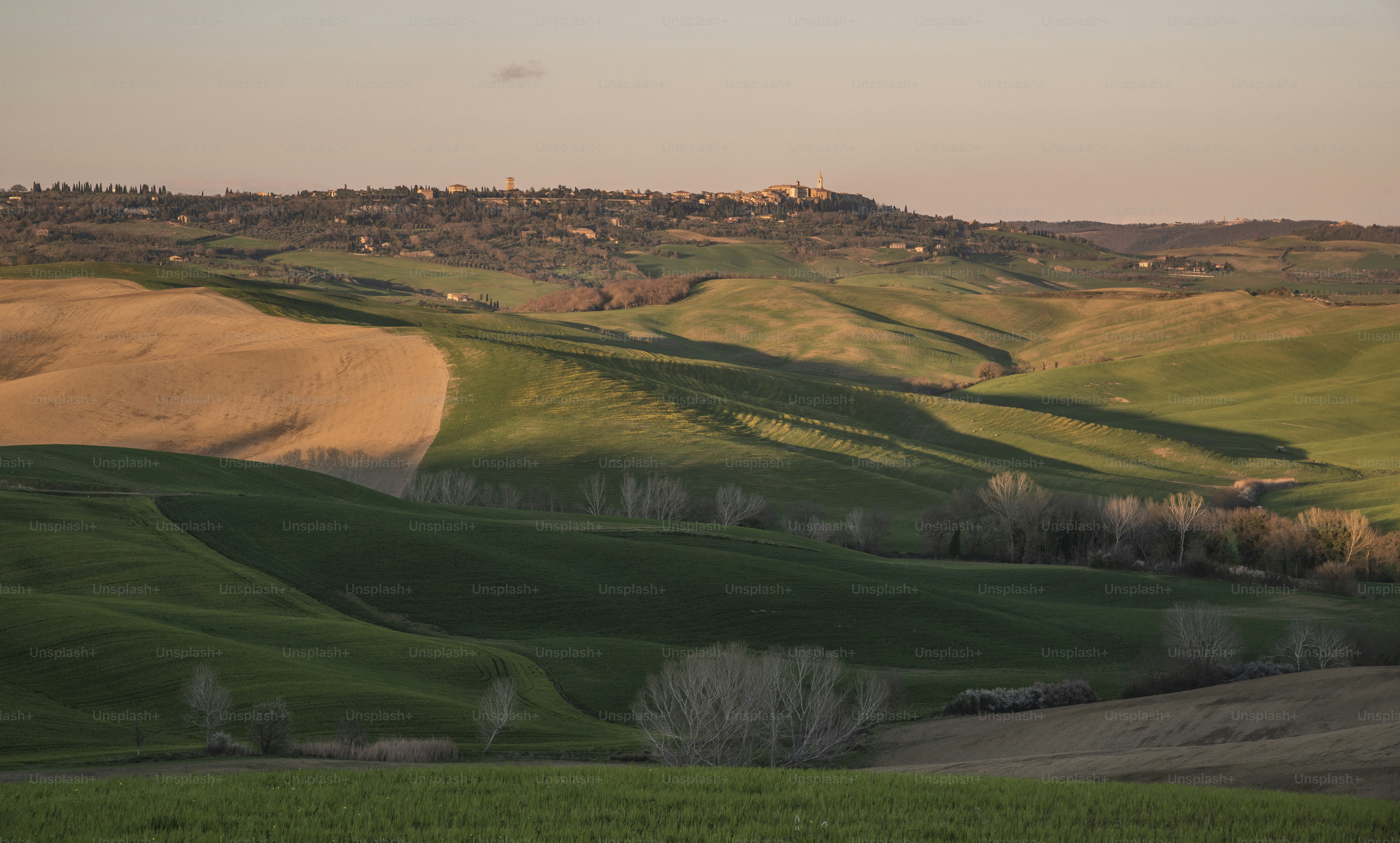 The sun is setting over the rolling hills photo – Landscape orientation ...