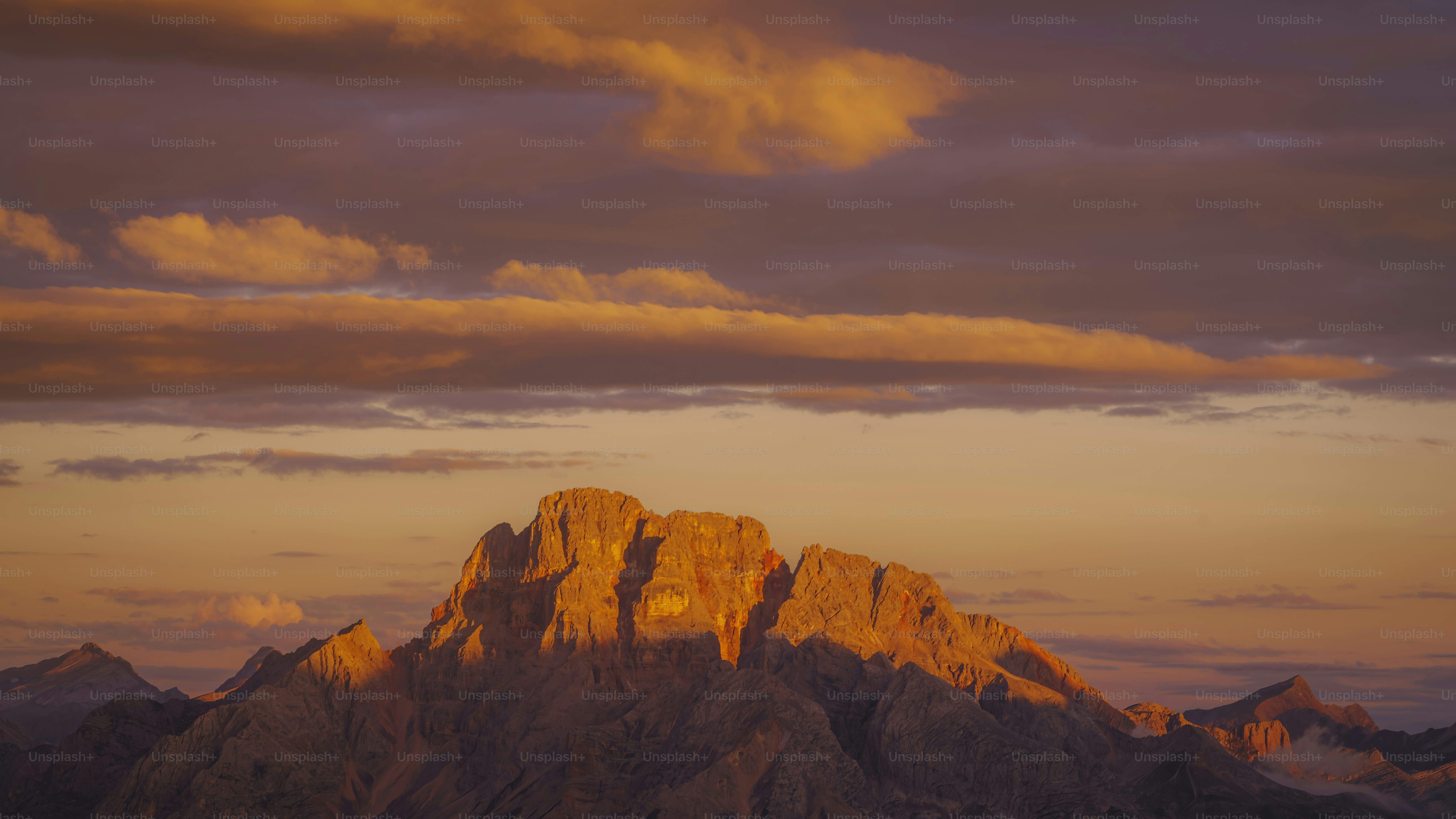 A group of mountains with clouds in the sky photo – Nature Image on ...
