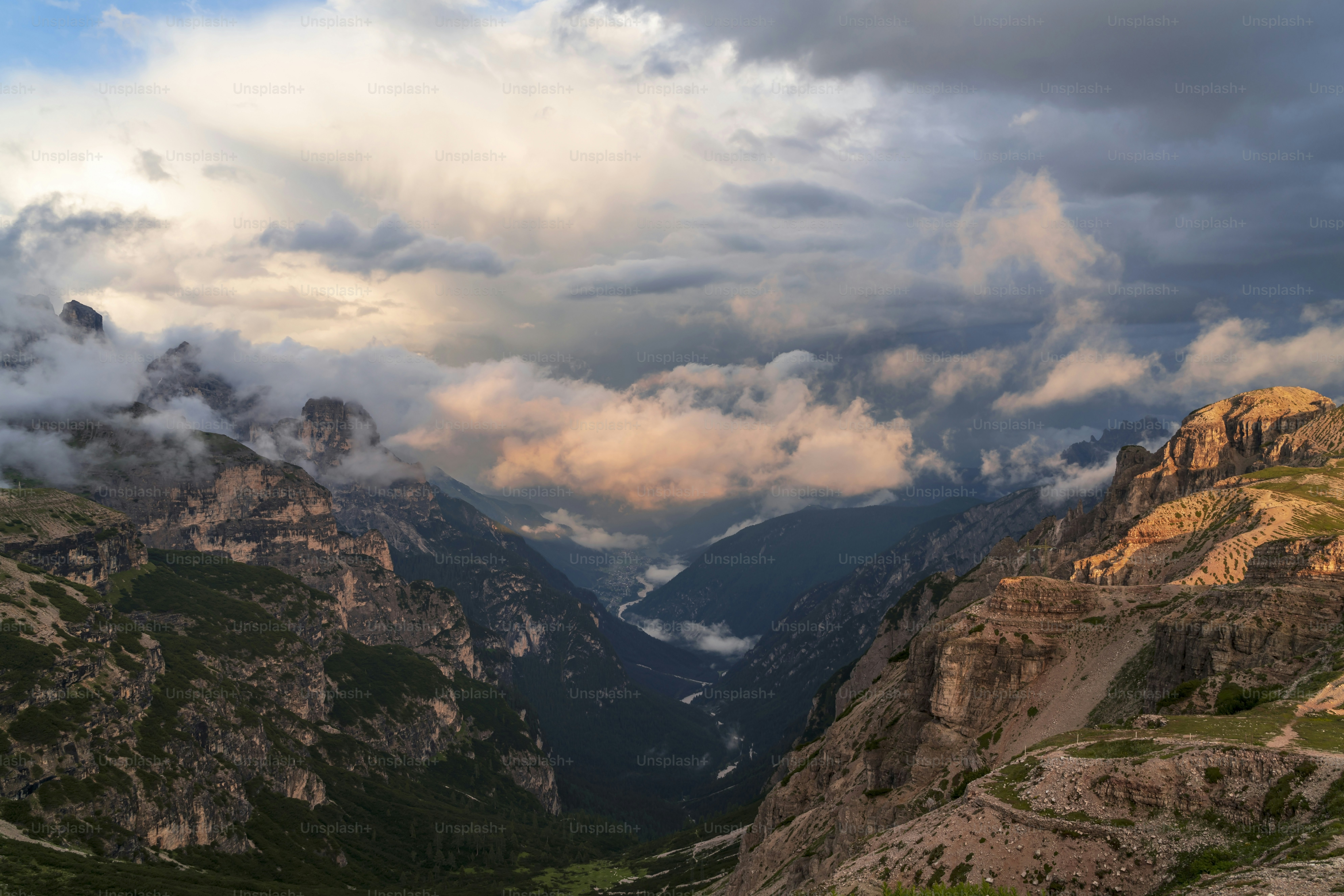 A view of a valley with mountains in the background photo – Italy Image ...
