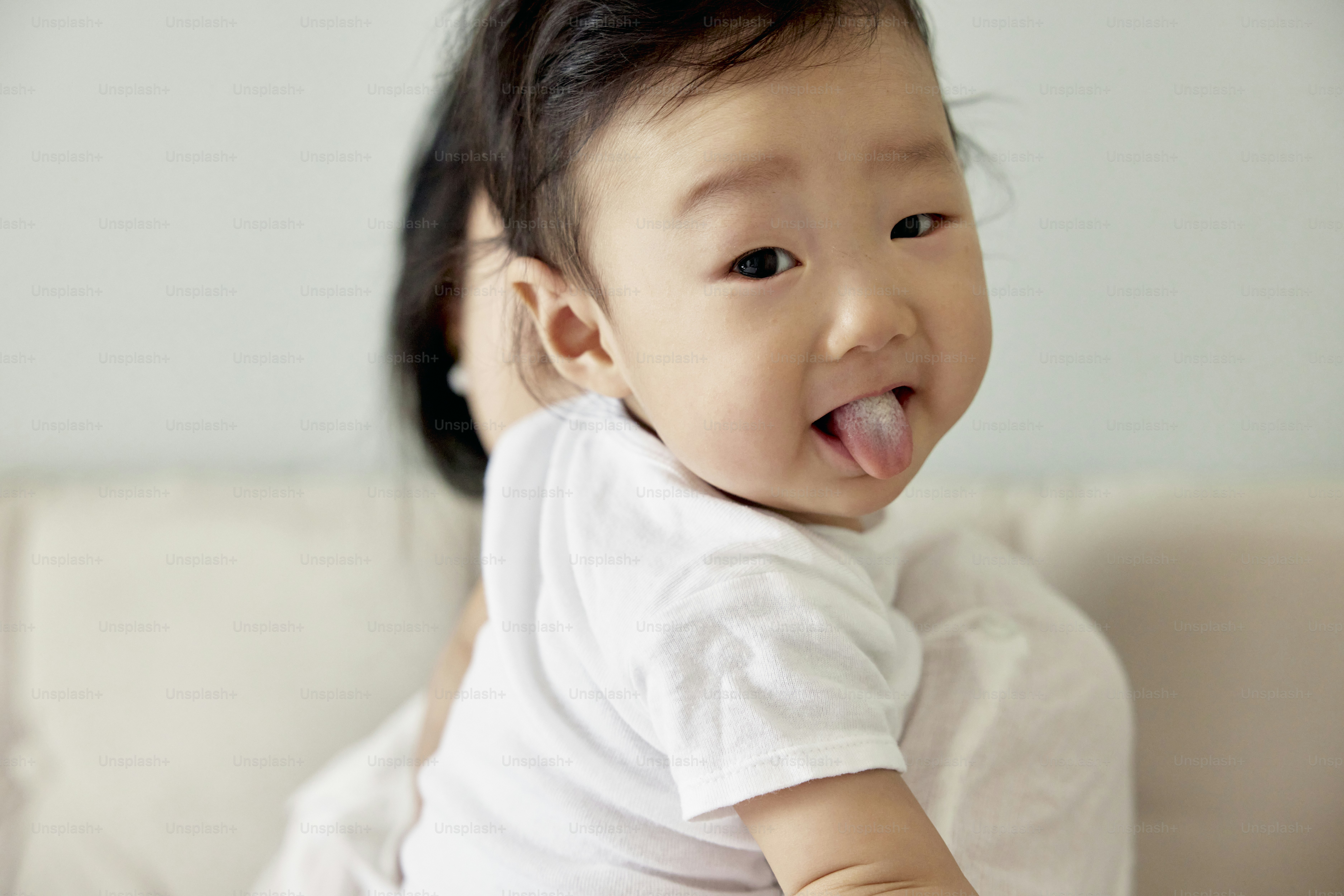 A close up of a baby wearing a white shirt photo – Baby Image on Unsplash