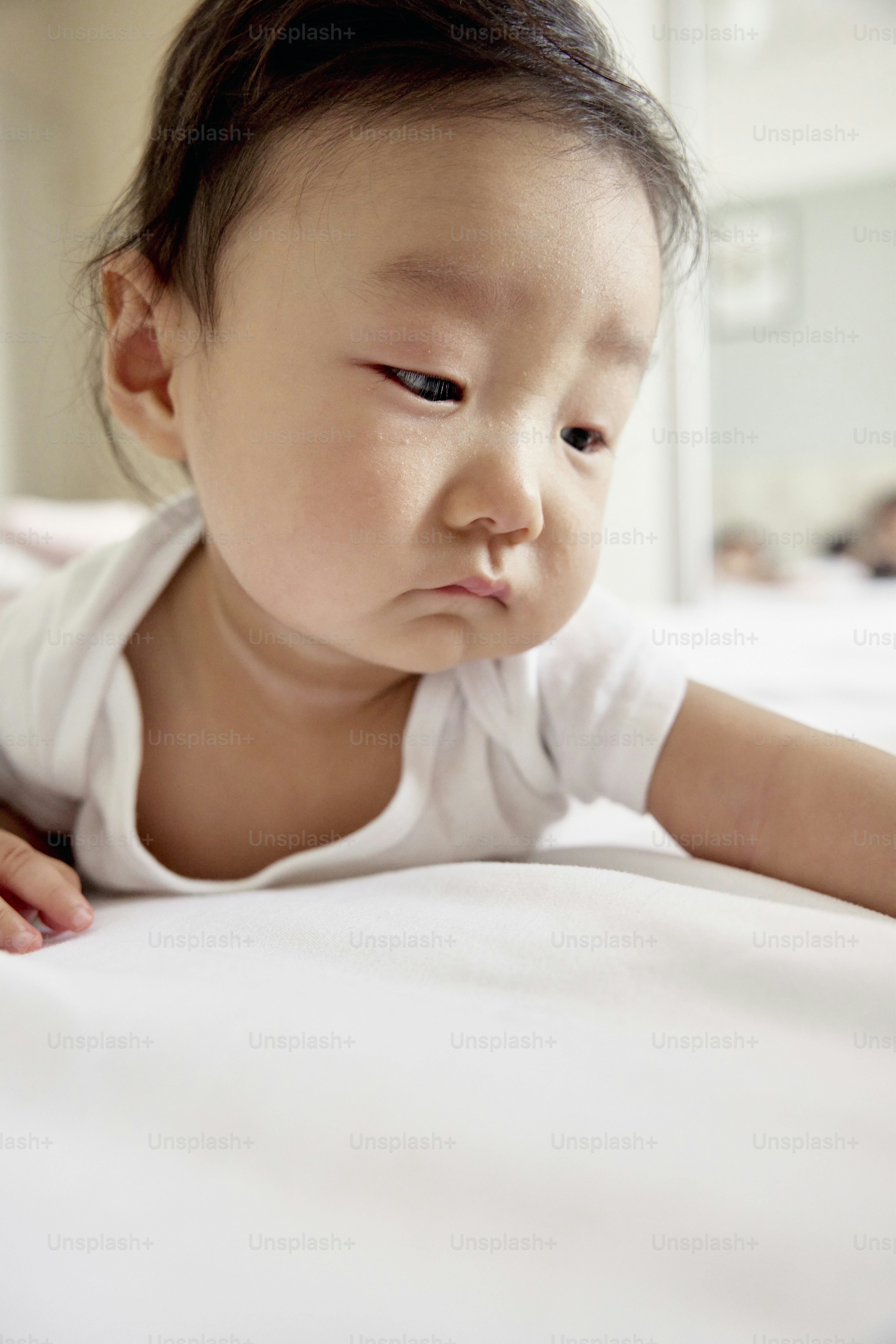 A woman laying on top of a bed next to a baby photo – Mom and baby ...