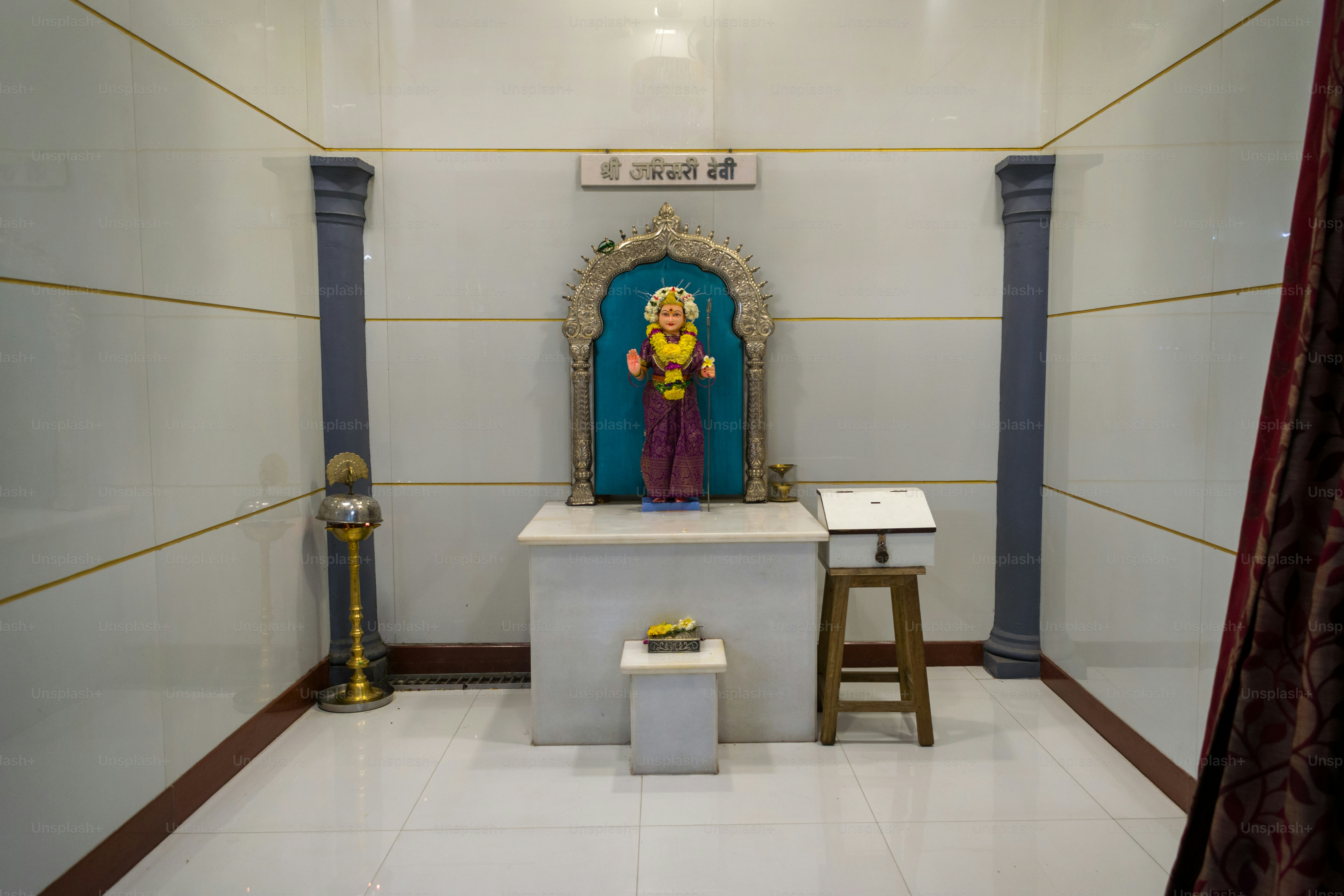 A small shrine with a statue of a person on it photo – Mumbai Image on ...