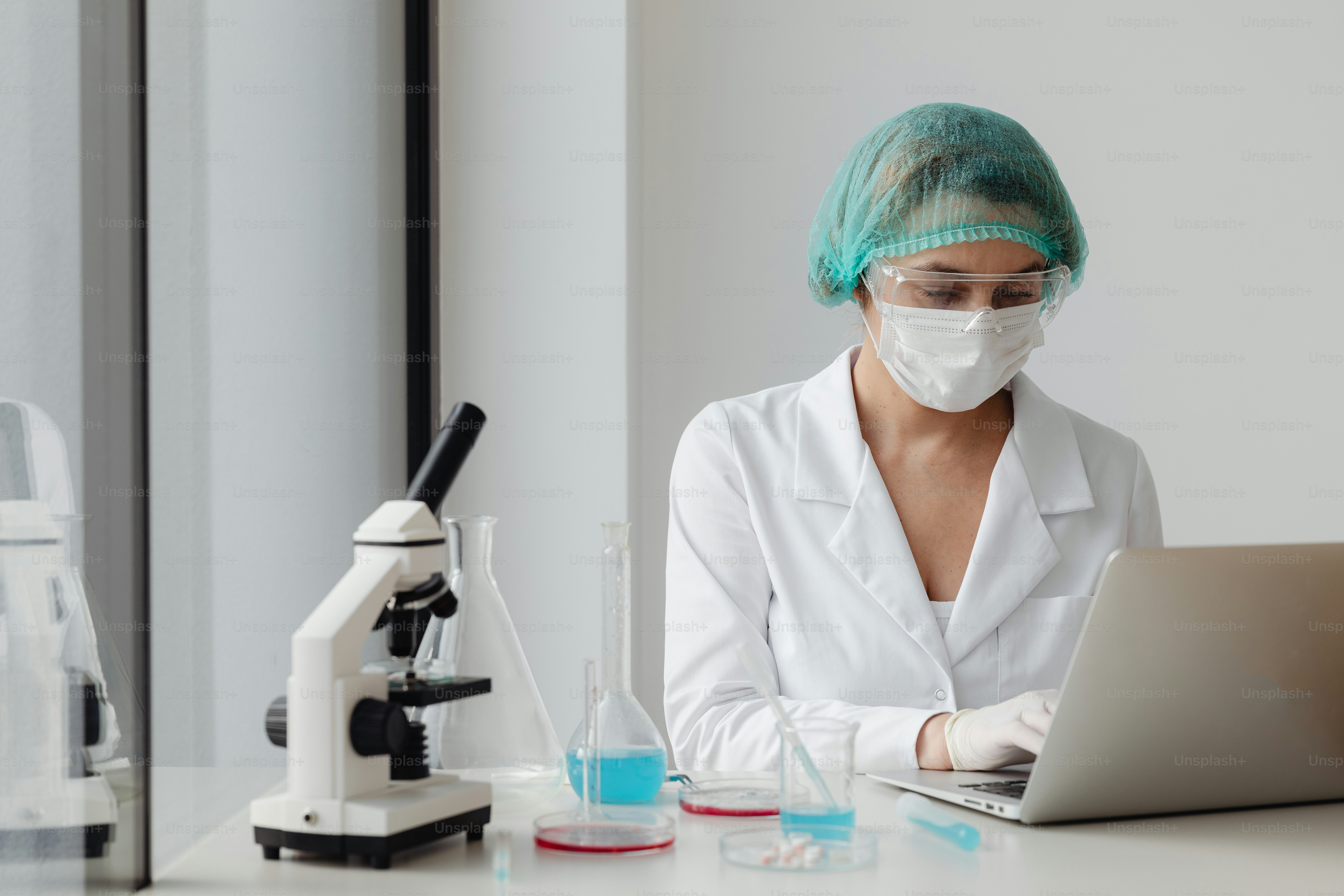 A woman in a white lab coat and goggles photo – Scientist Image on Unsplash