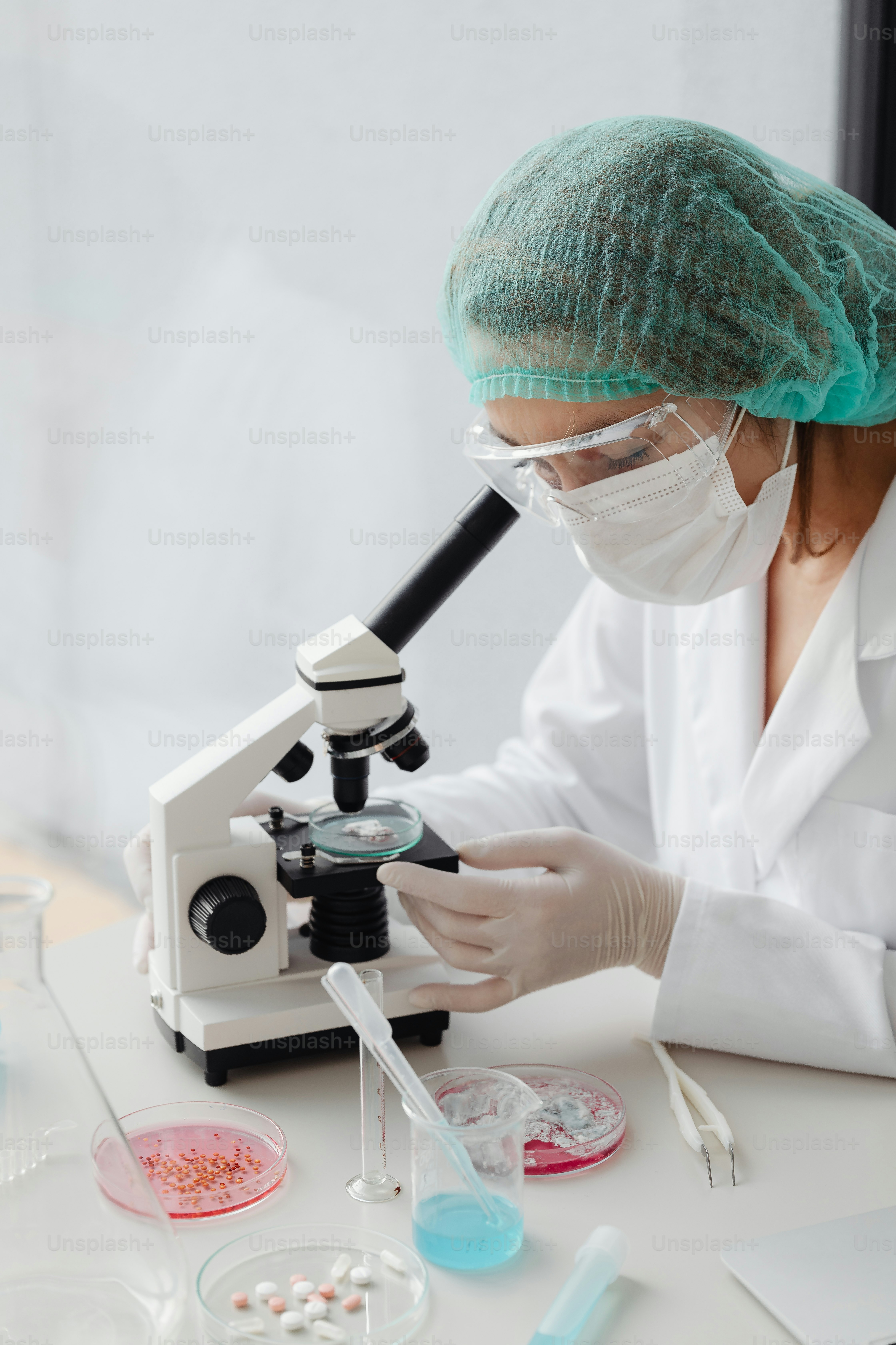 A person in white lab coat holding a green substance photo – Scientist ...