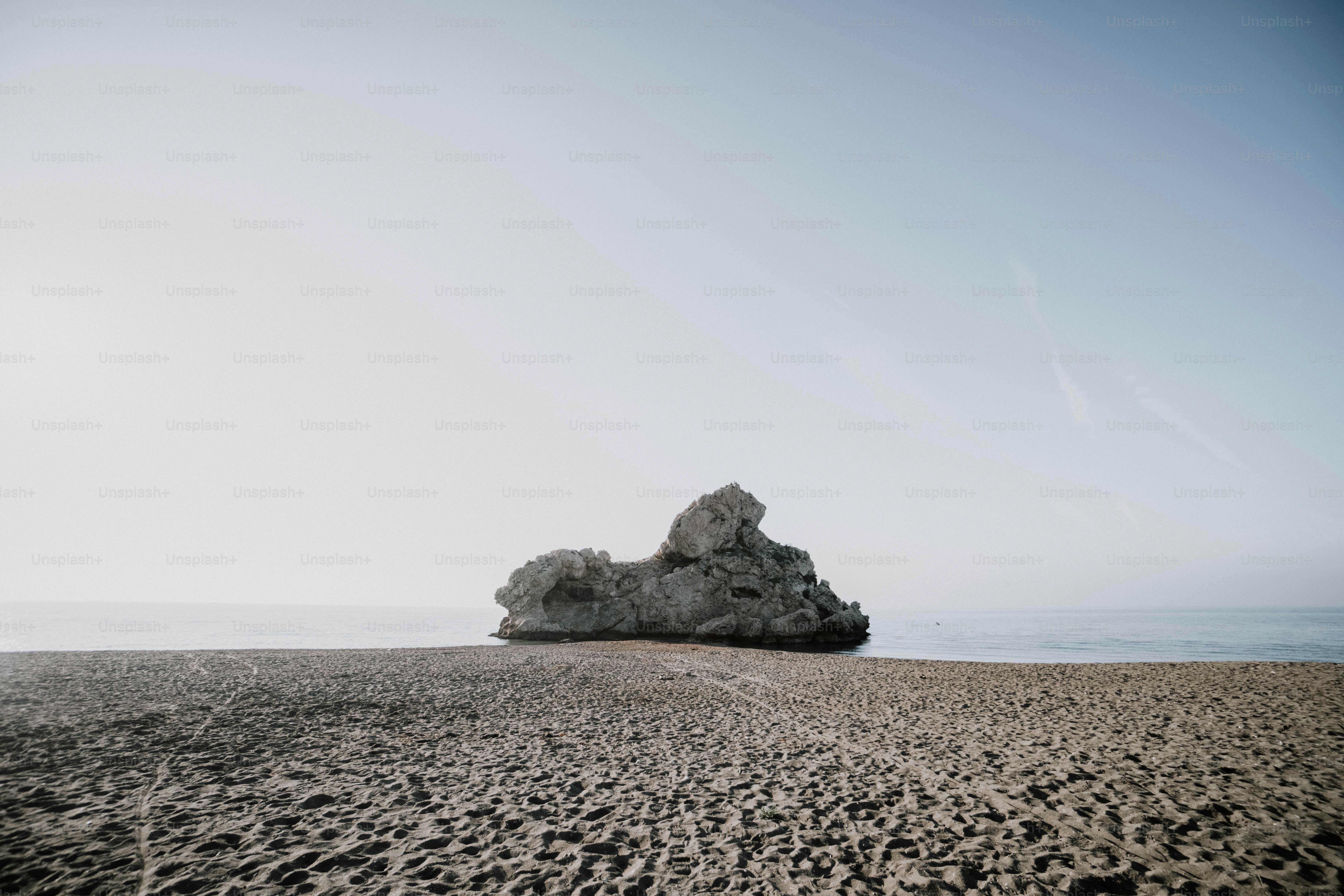 A mountain with a very tall rock on top of it photo – Rock background ...