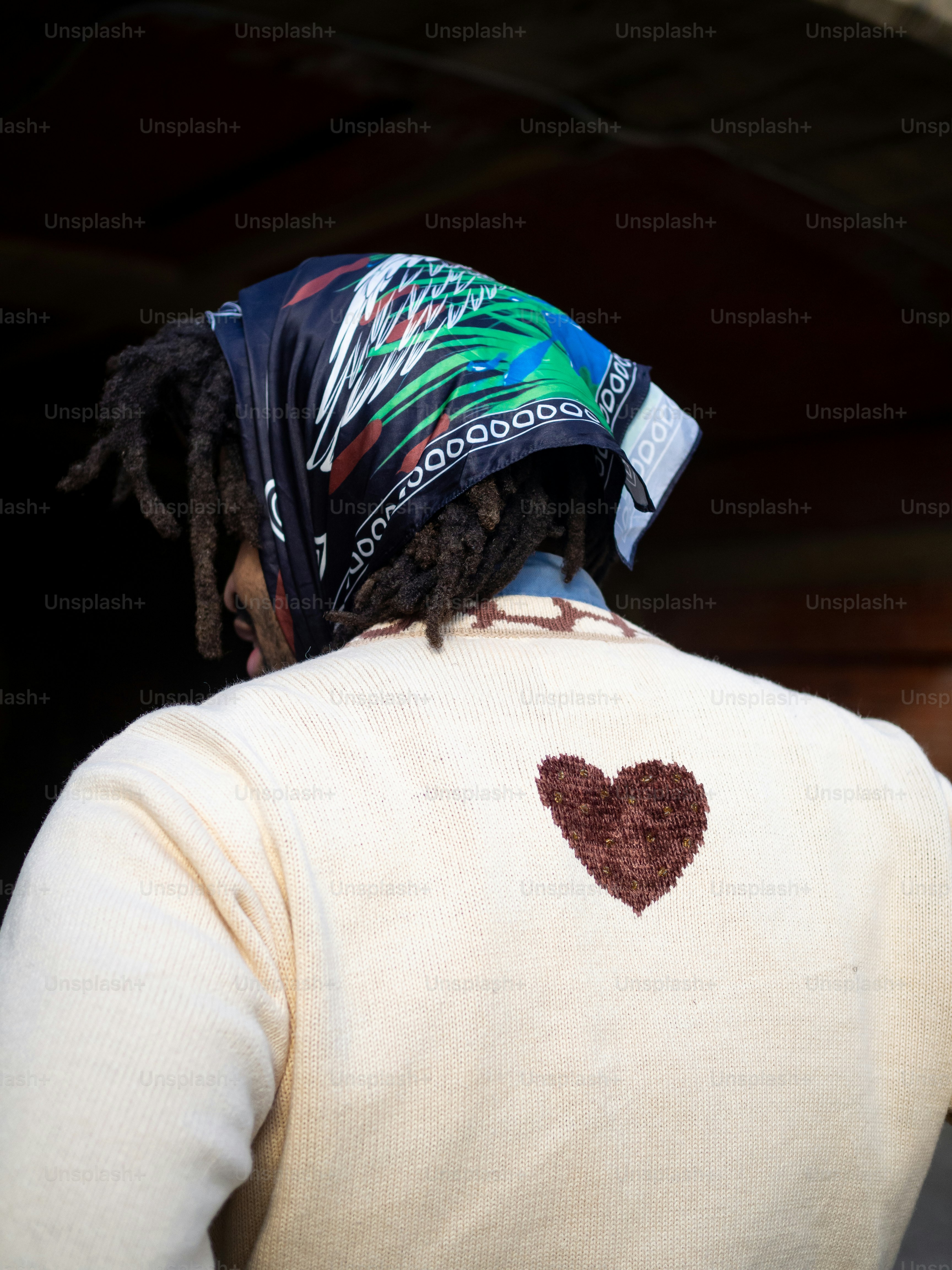 A man with dreadlocks wearing a sweater with a heart on it photo – Love ...