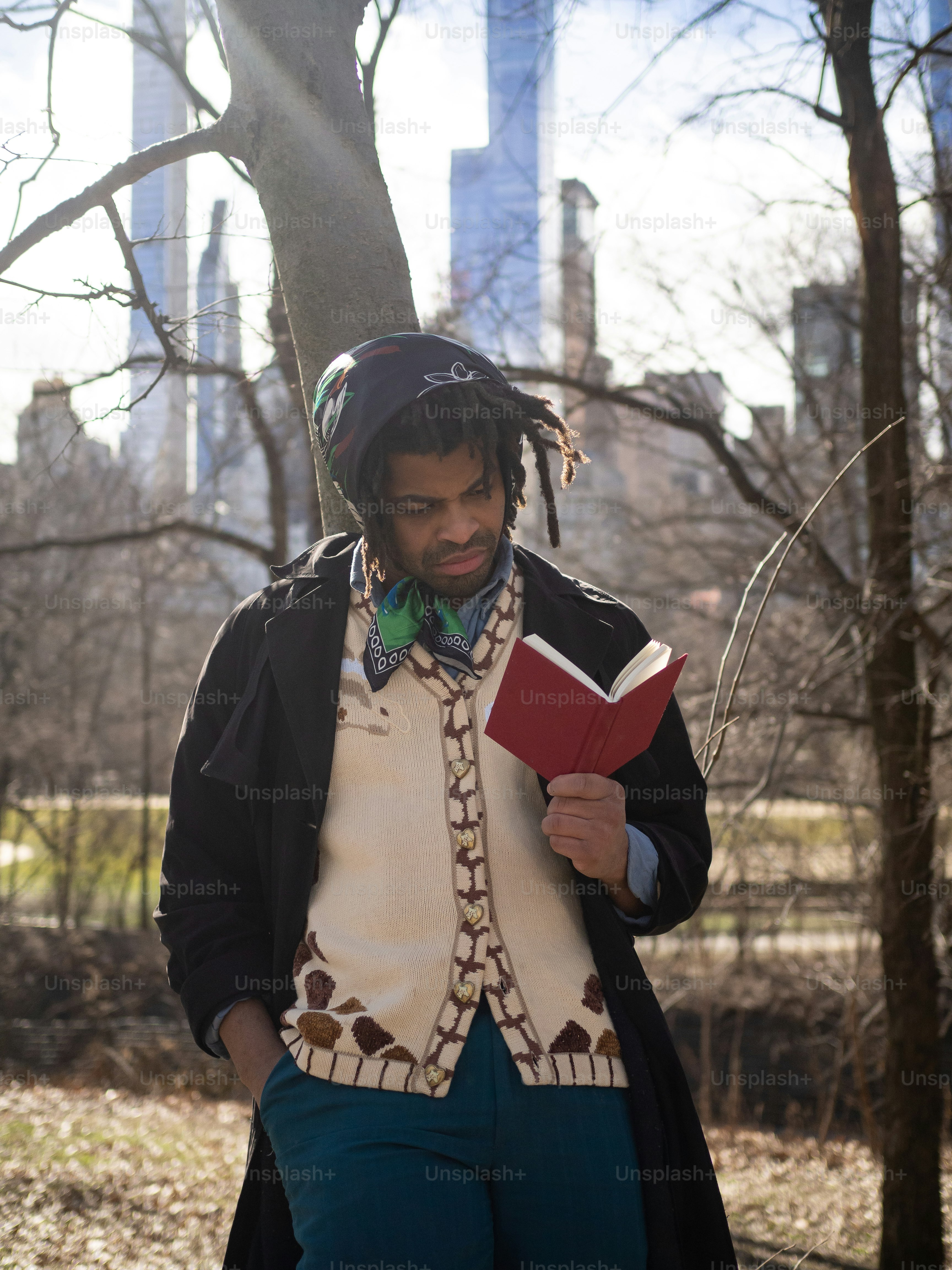 A man with dreadlocks is reading a book photo – Man Image on Unsplash
