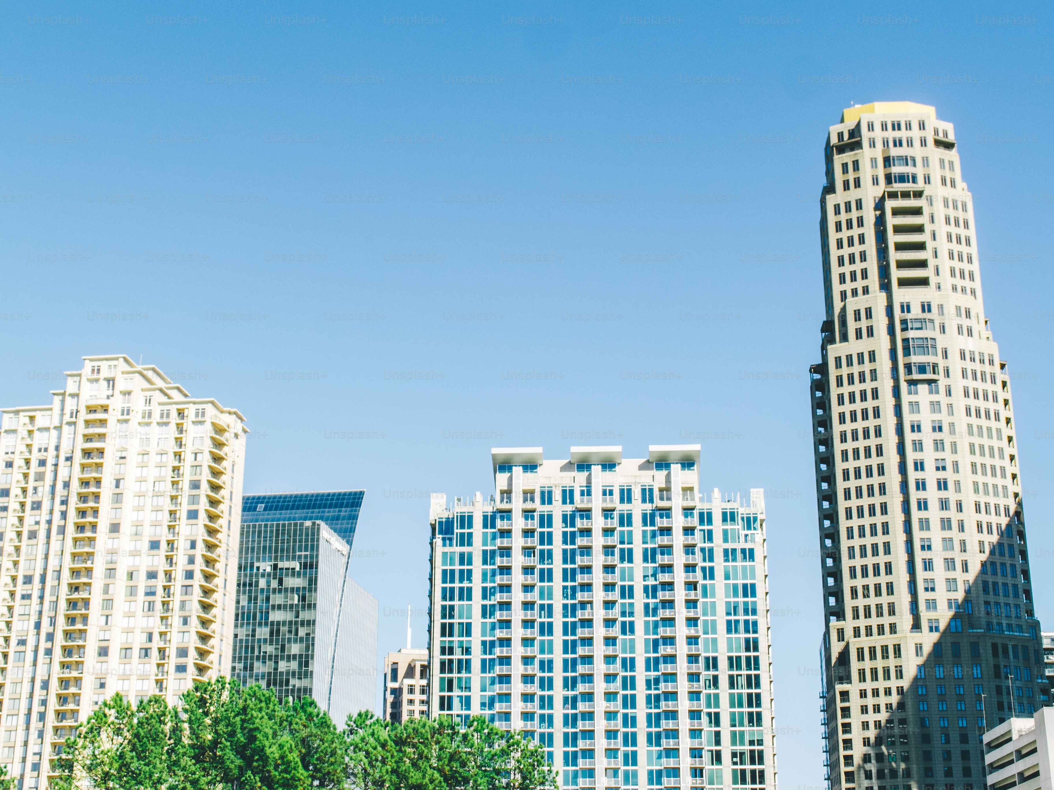 A group of tall buildings sitting next to each other photo – City Image ...