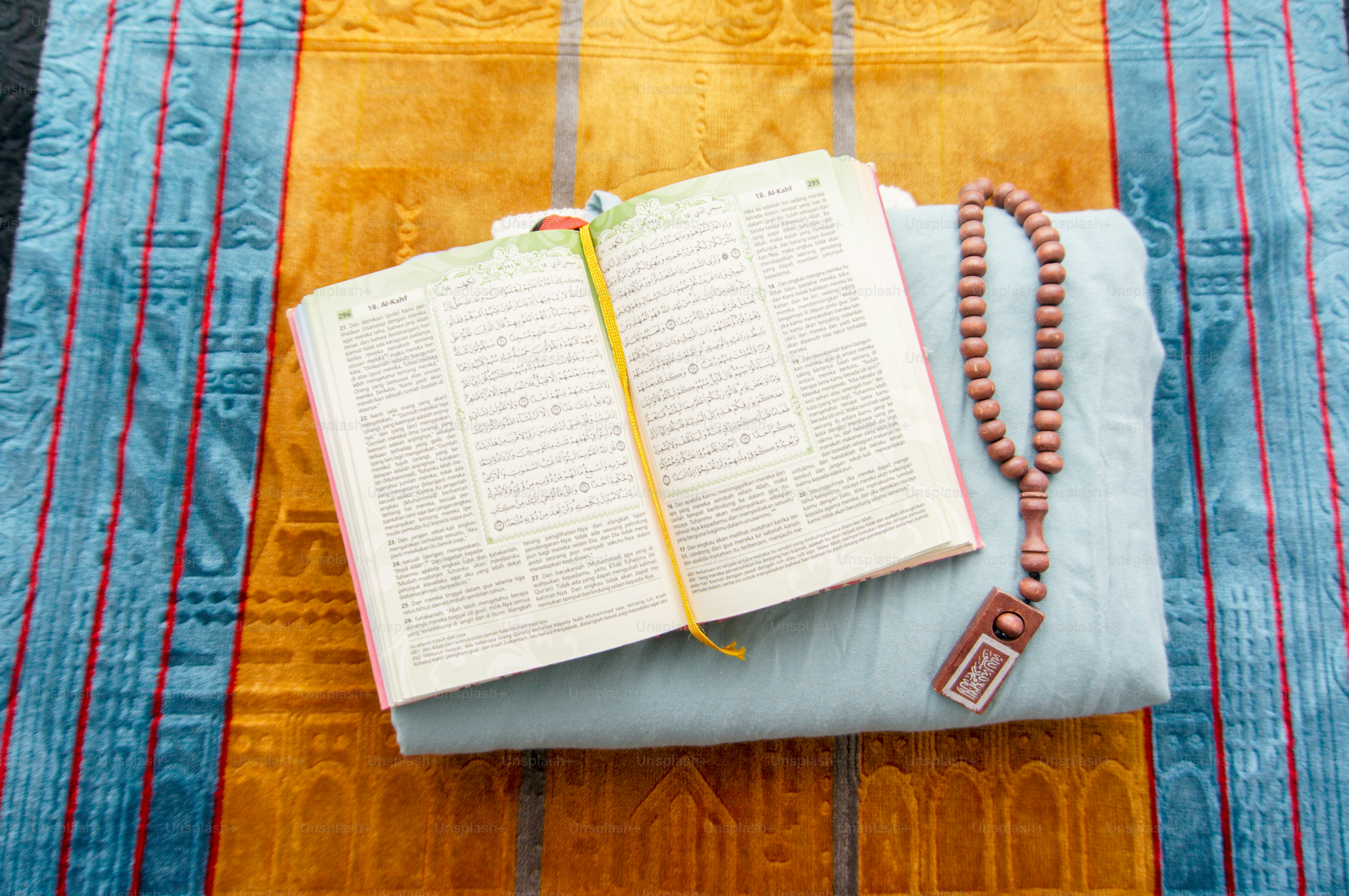A rosary and a book on a bed photo – Islam Image on Unsplash
