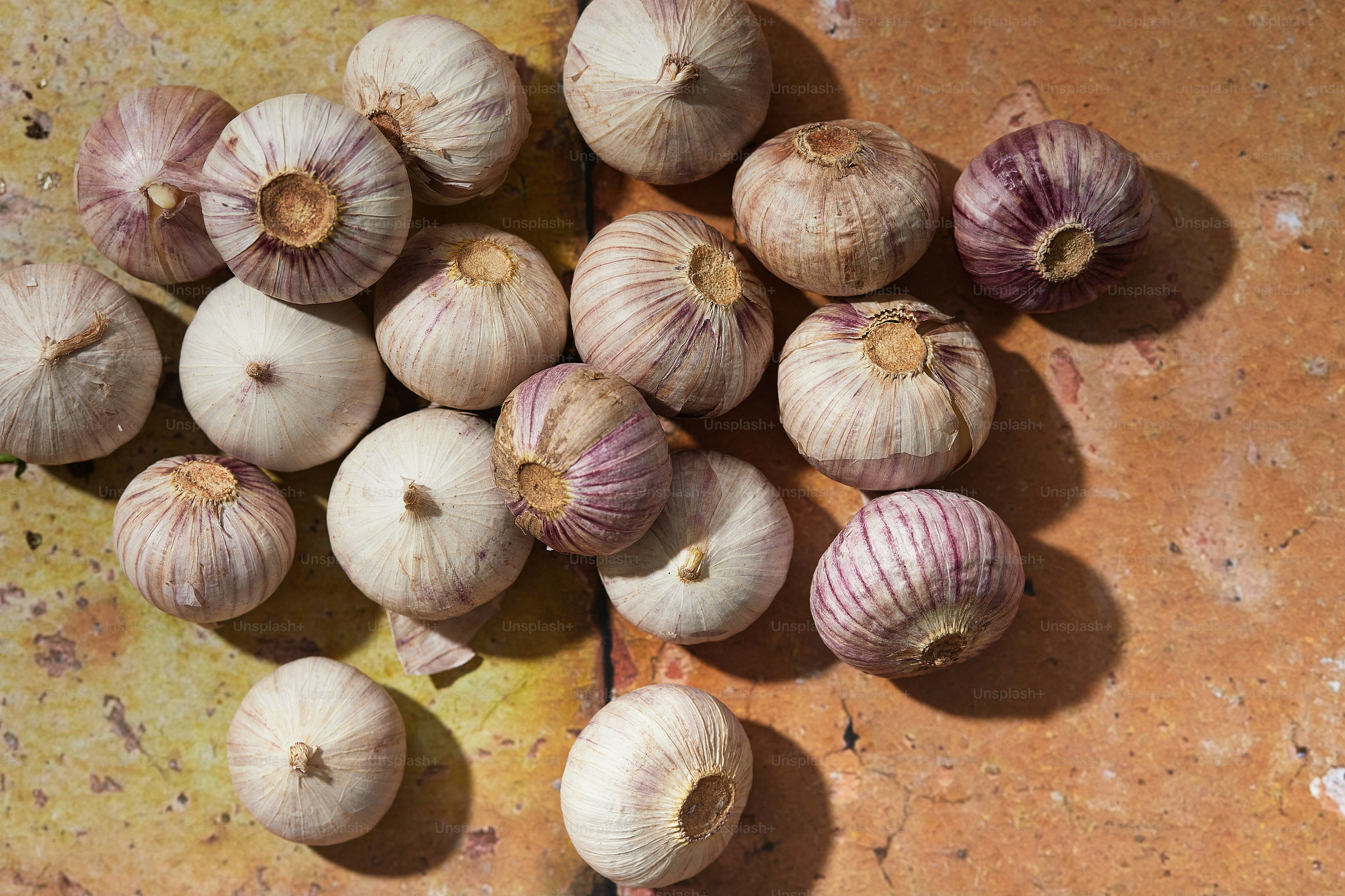 A bunch of garlic sitting on top of a table photo – Garlic Image on ...