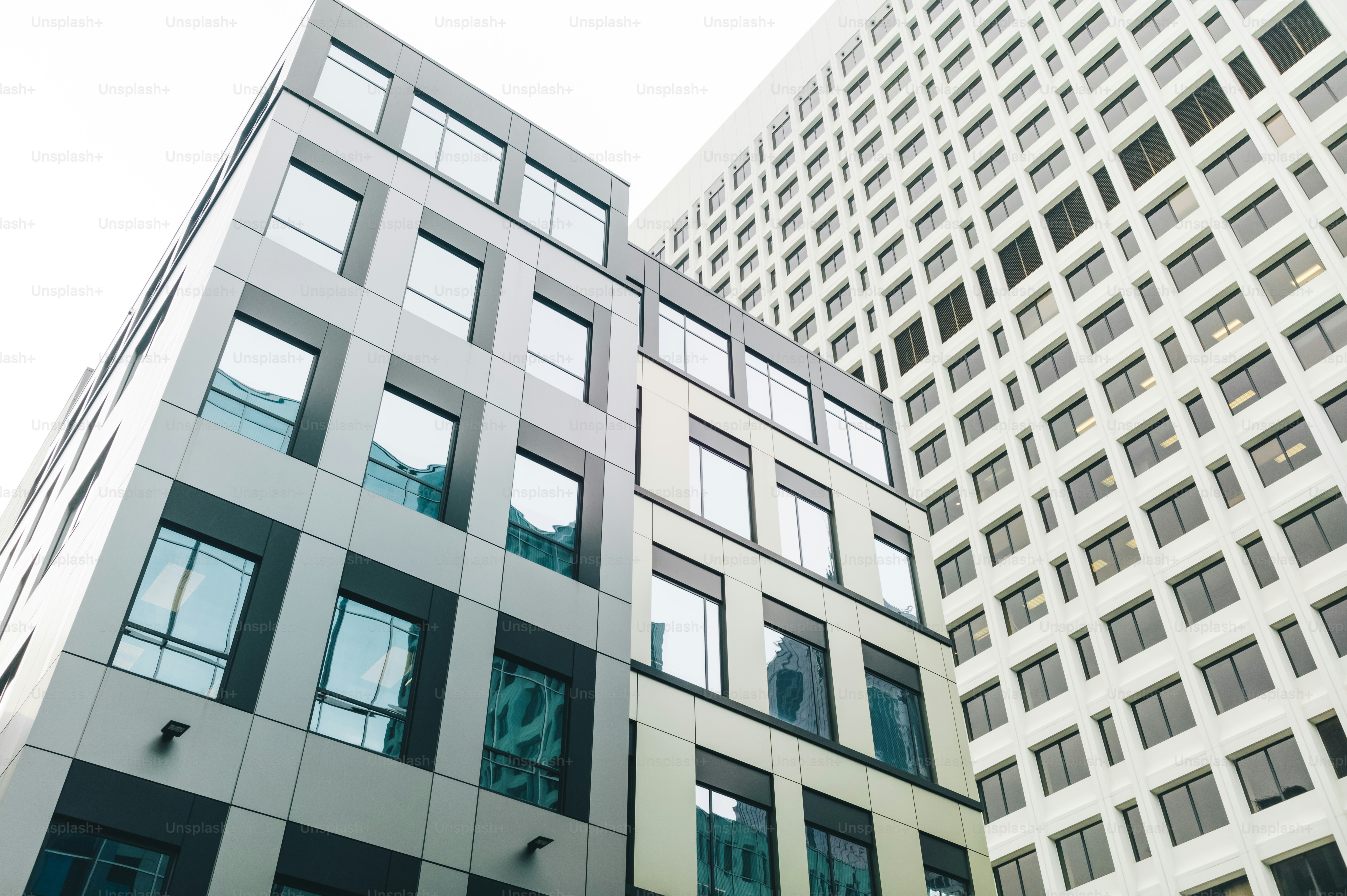 A couple of tall buildings sitting next to each other photo ...