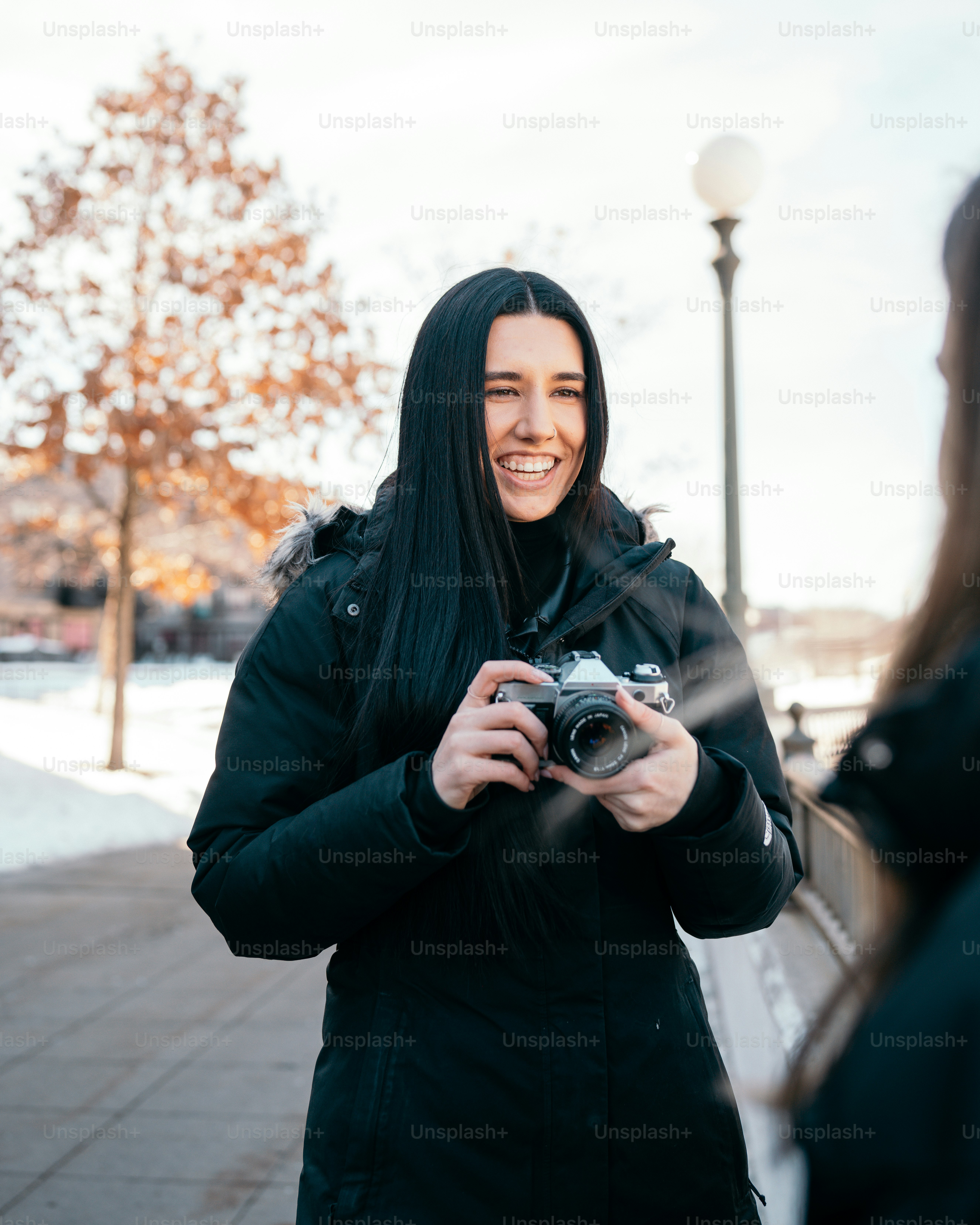 A woman taking a picture of herself with a camera photo – Taking photos ...