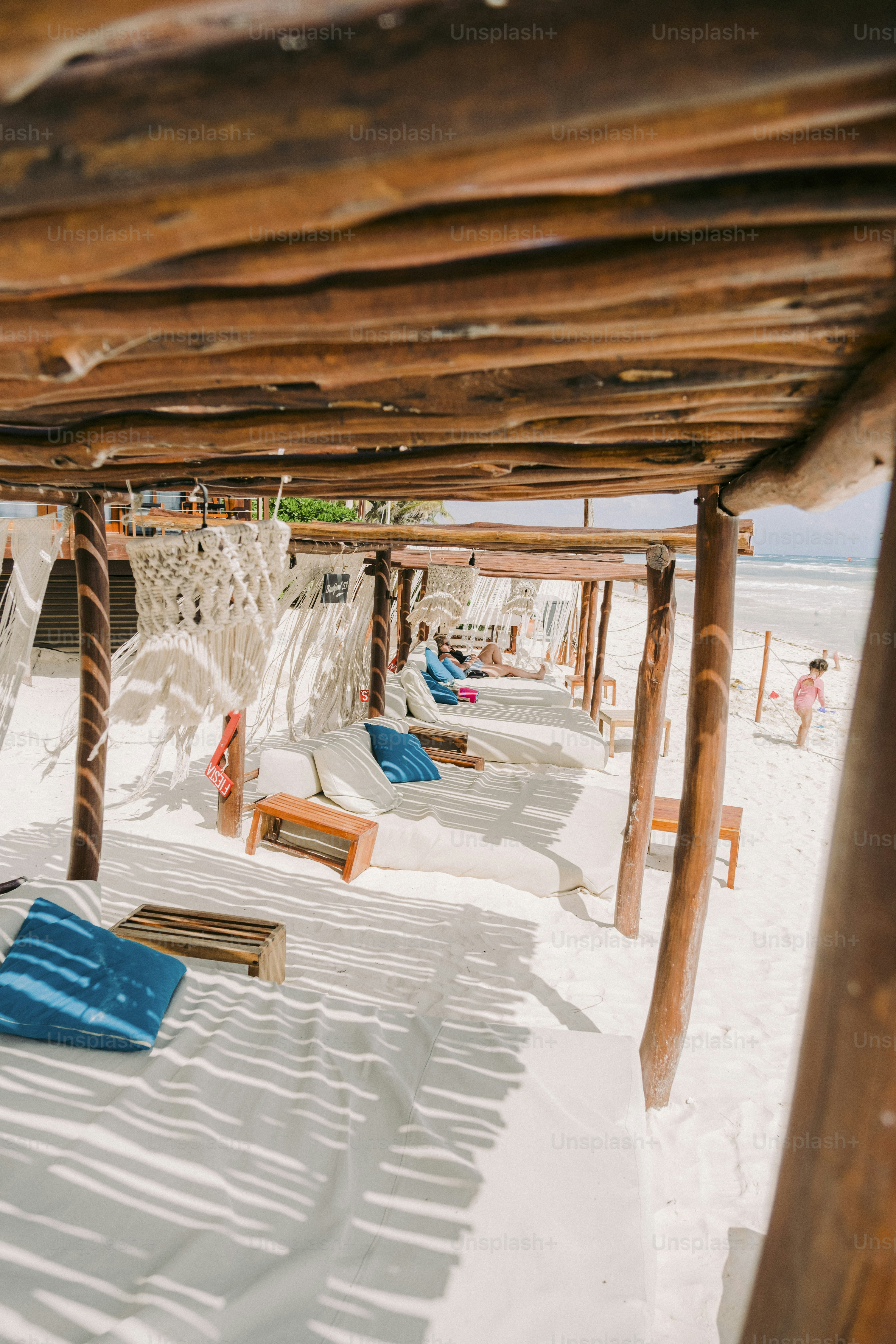 A row of hammocks sitting on top of a sandy beach photo – Spring break ...