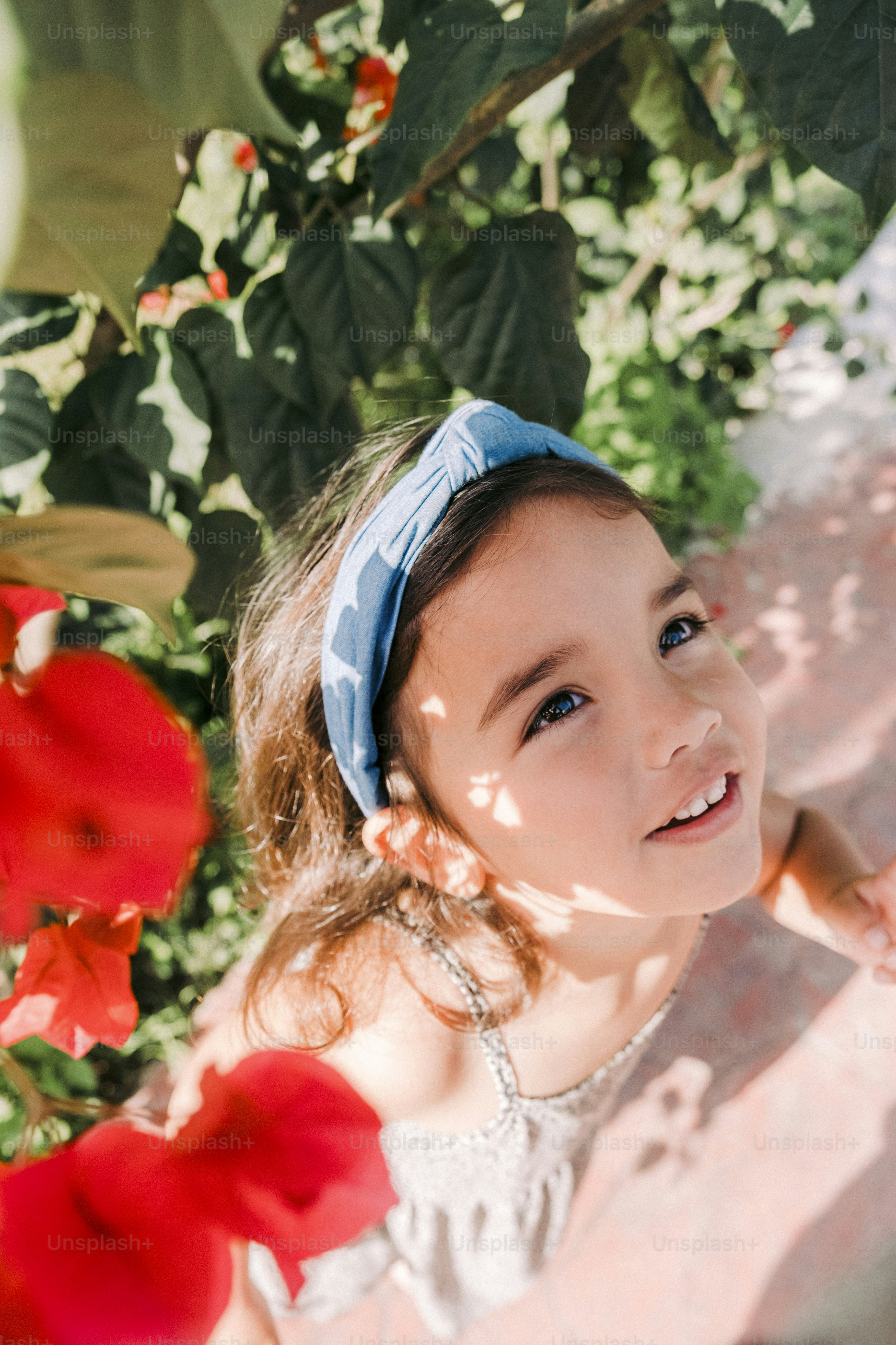 A little girl that is standing in the grass photo – Spring break Image ...