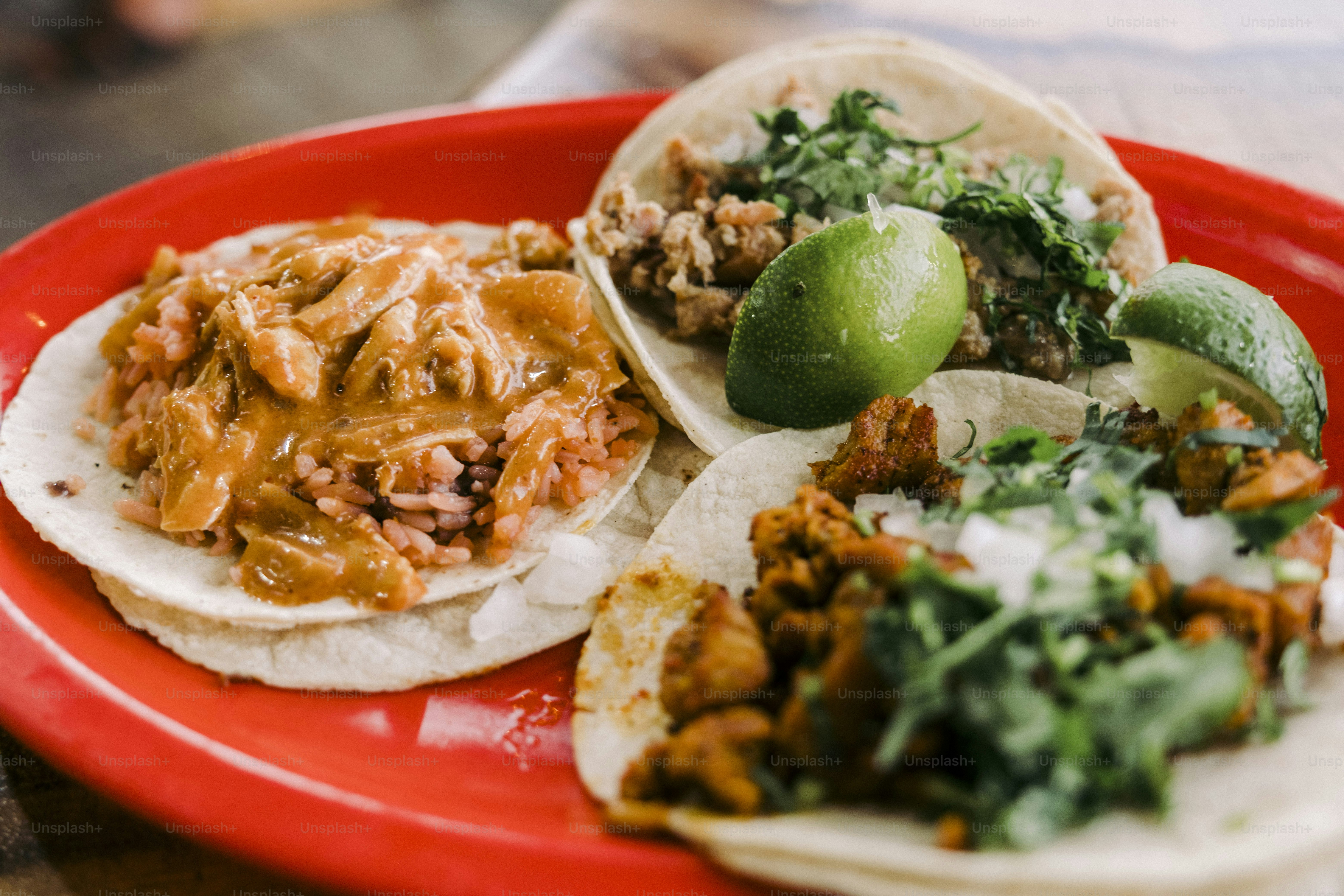 A red plate topped with three tacos and a lime photo – Spring break ...