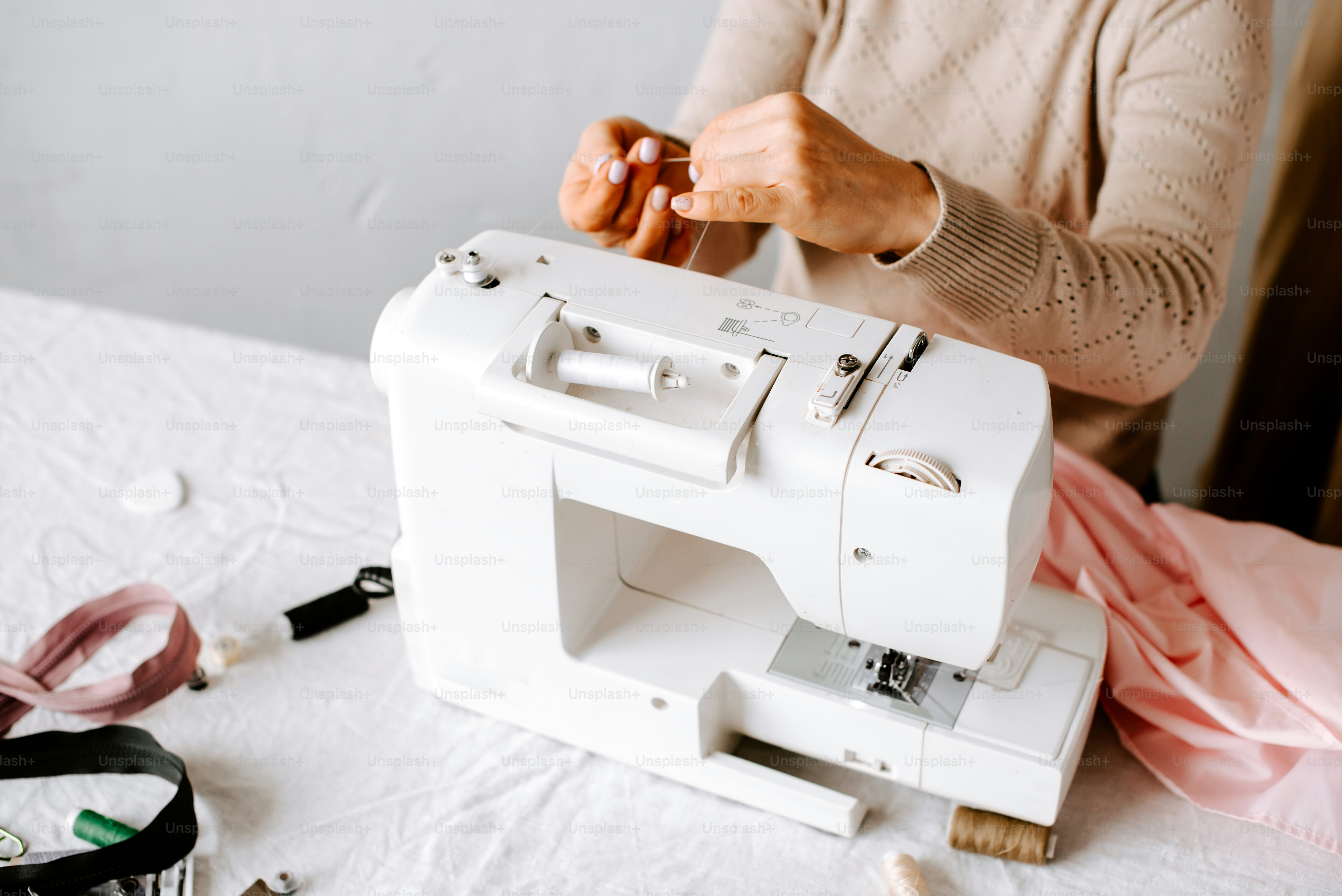 A woman using a sewing machine on a table photo – Sewing Image on Unsplash