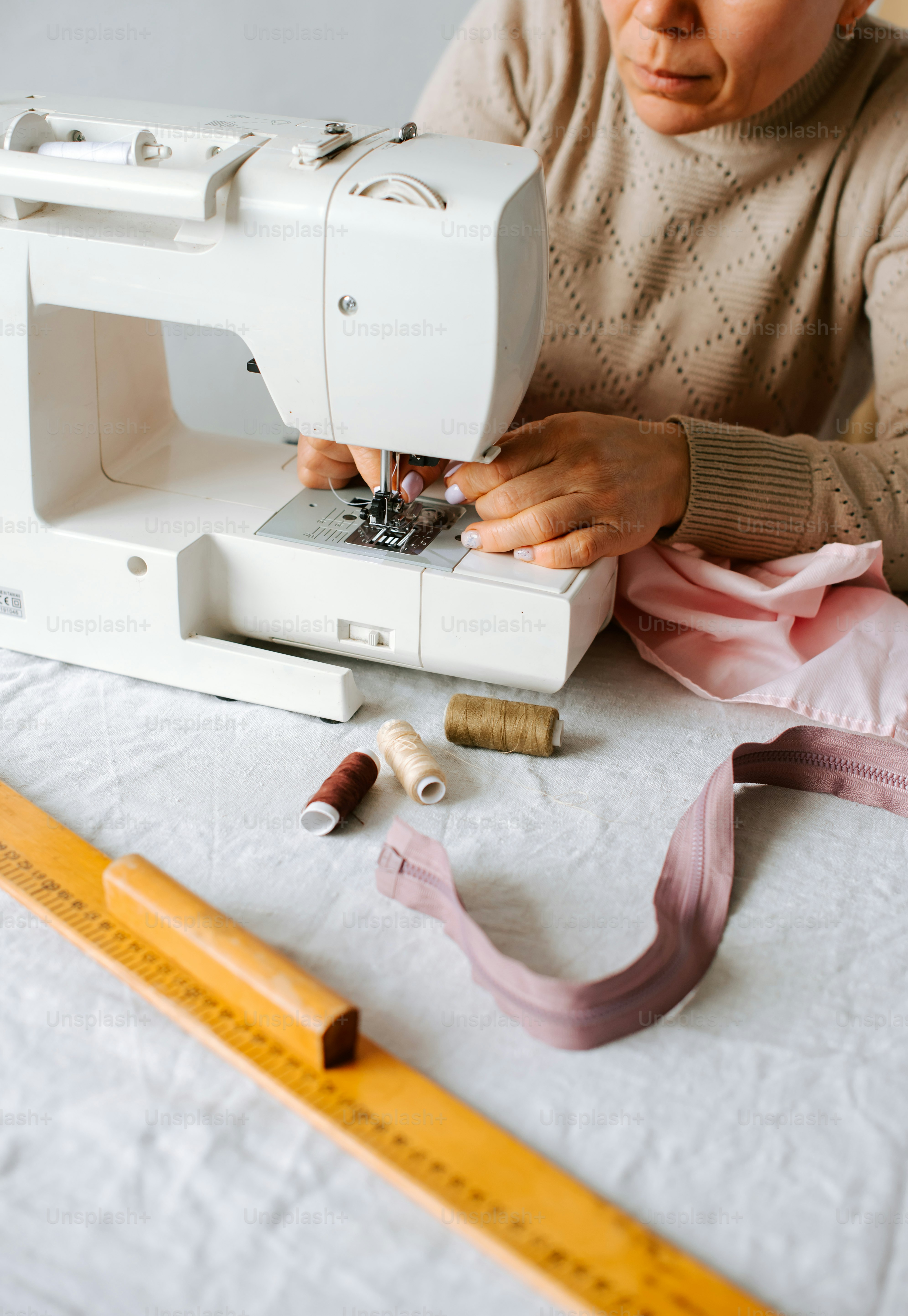 A sewing machine sitting on top of a white table photo – Tailor Image ...