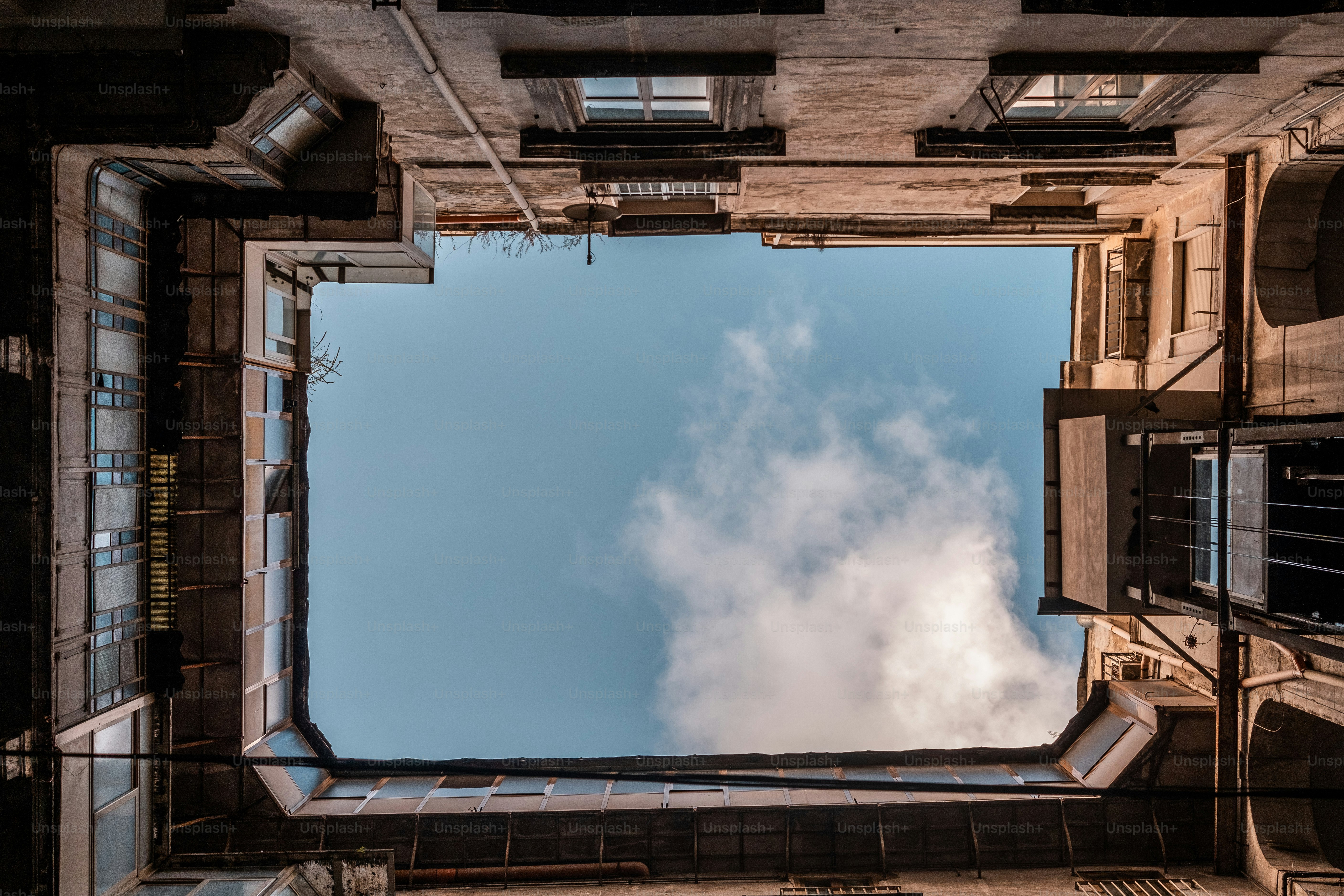 A view of the sky from inside a building photo – Italy Image on Unsplash