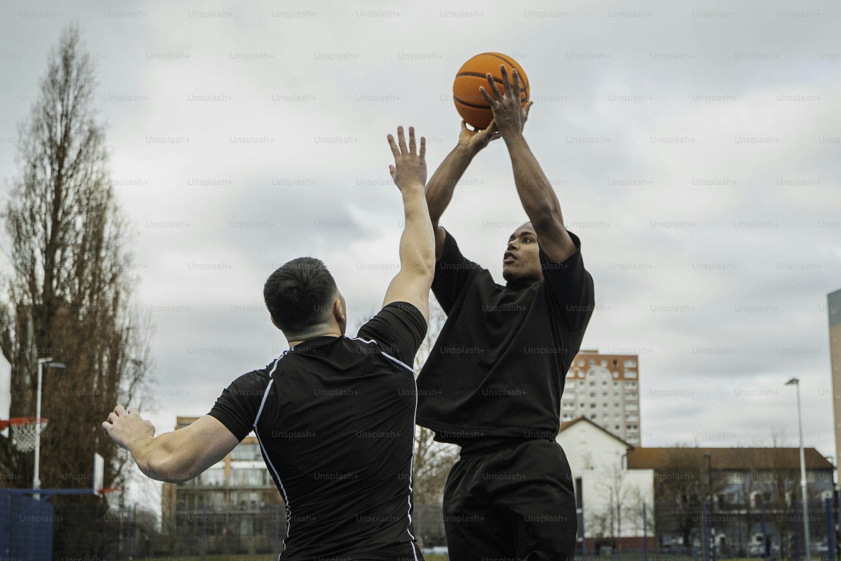 A couple of men playing a game of basketball photo – Compete Image on ...