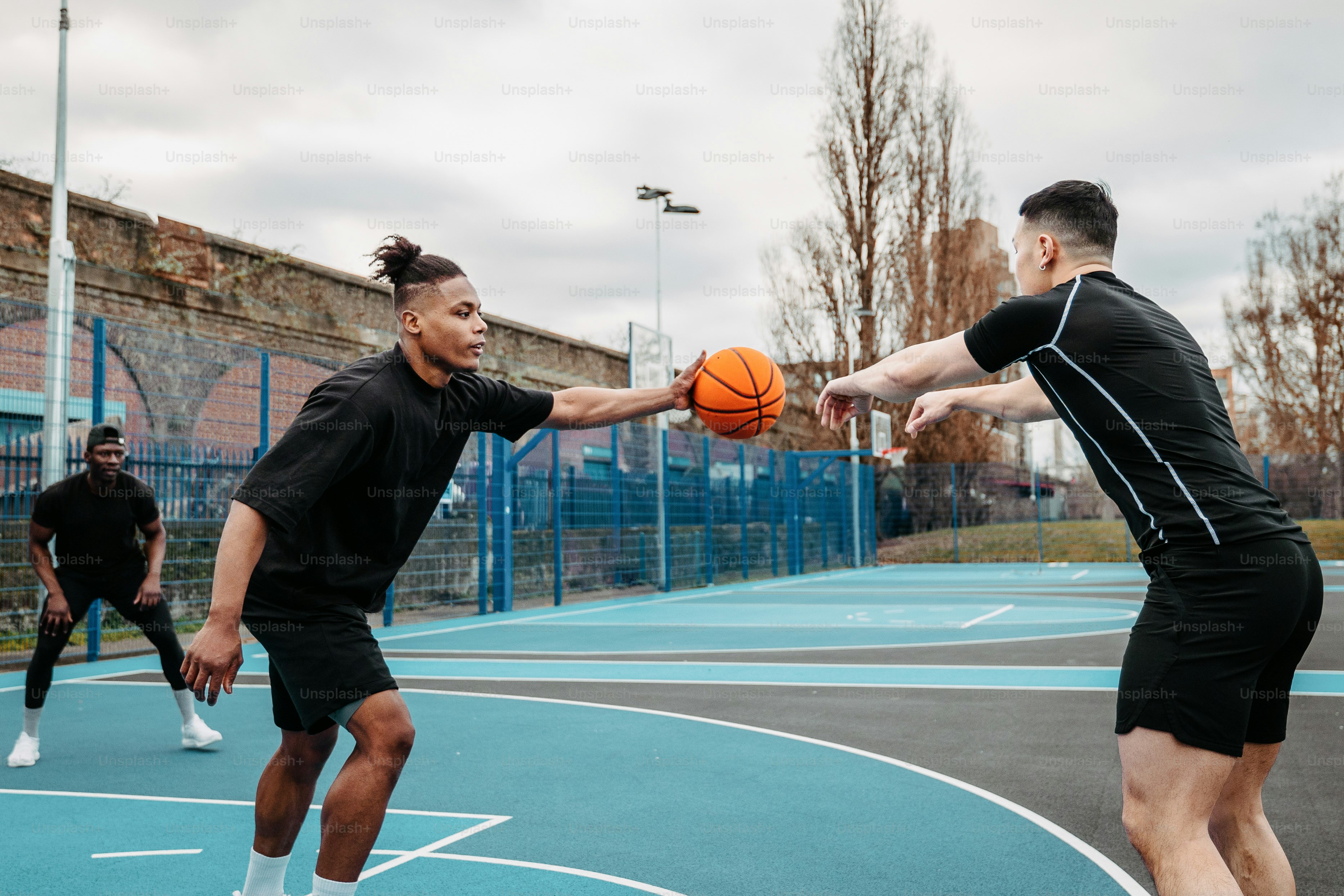 A couple of men playing a game of basketball photo – Advantages Image ...