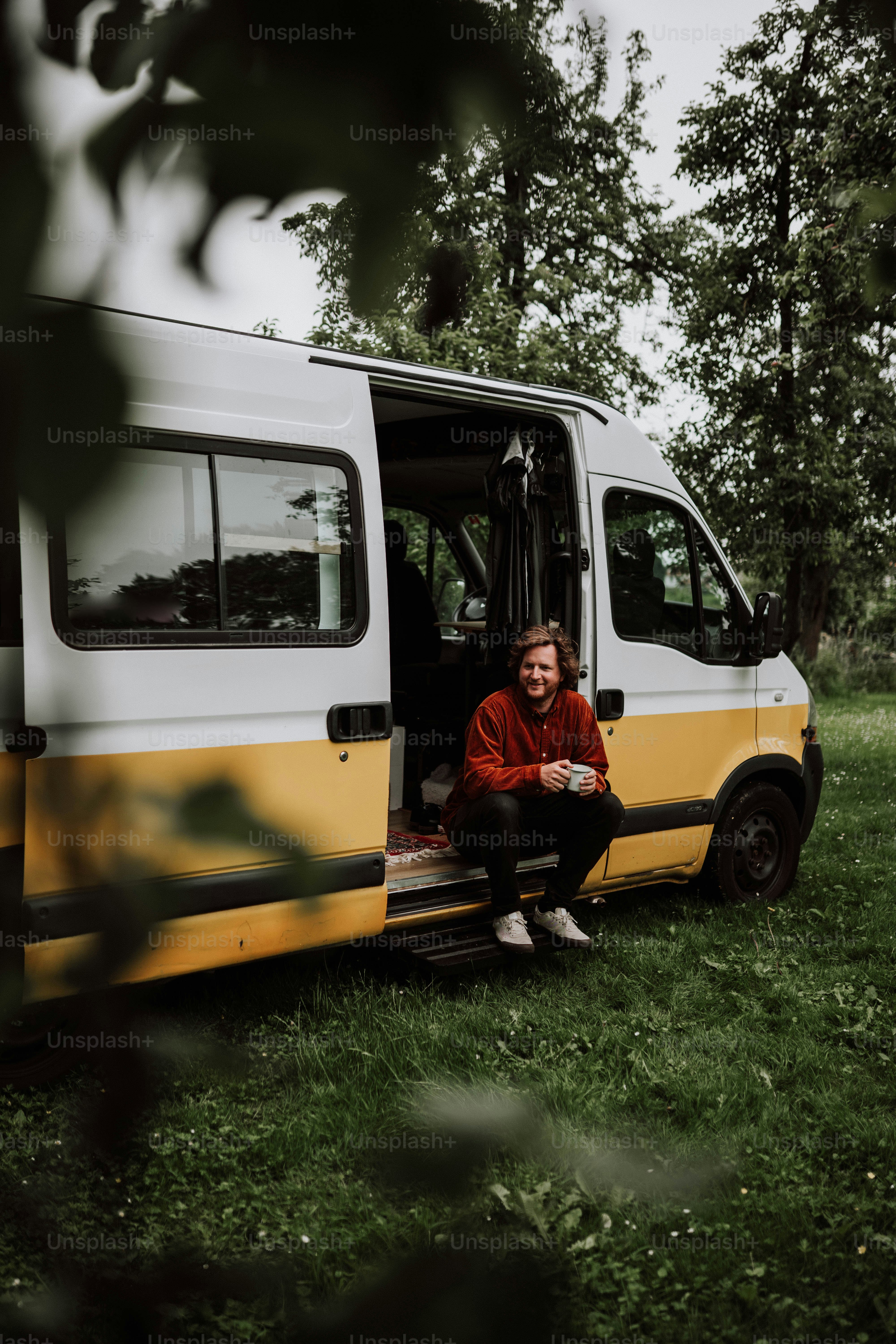 A man sitting in the back of a van photo – Spring break Image on Unsplash
