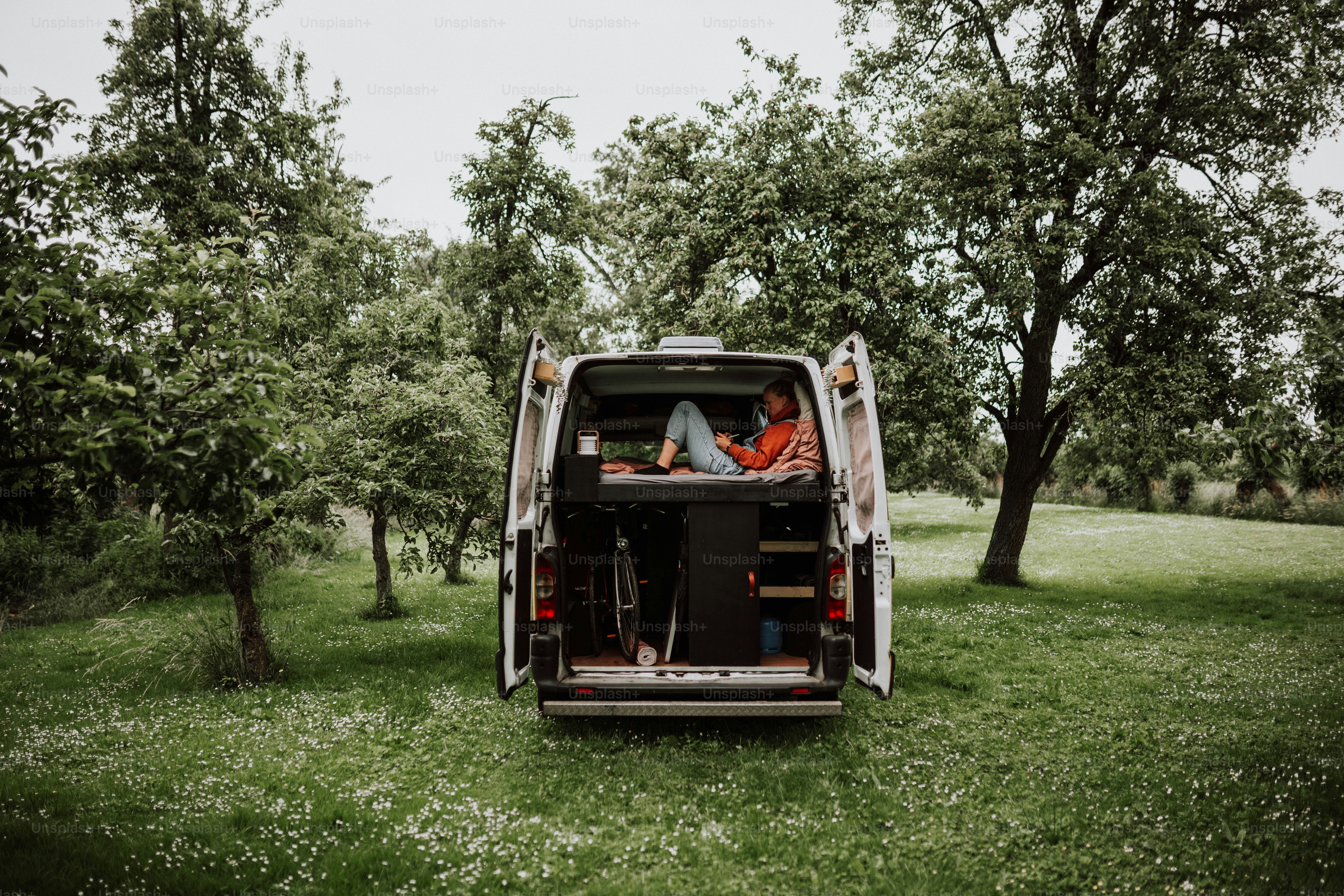 A man sitting in the back of a van photo – Spring break Image on Unsplash