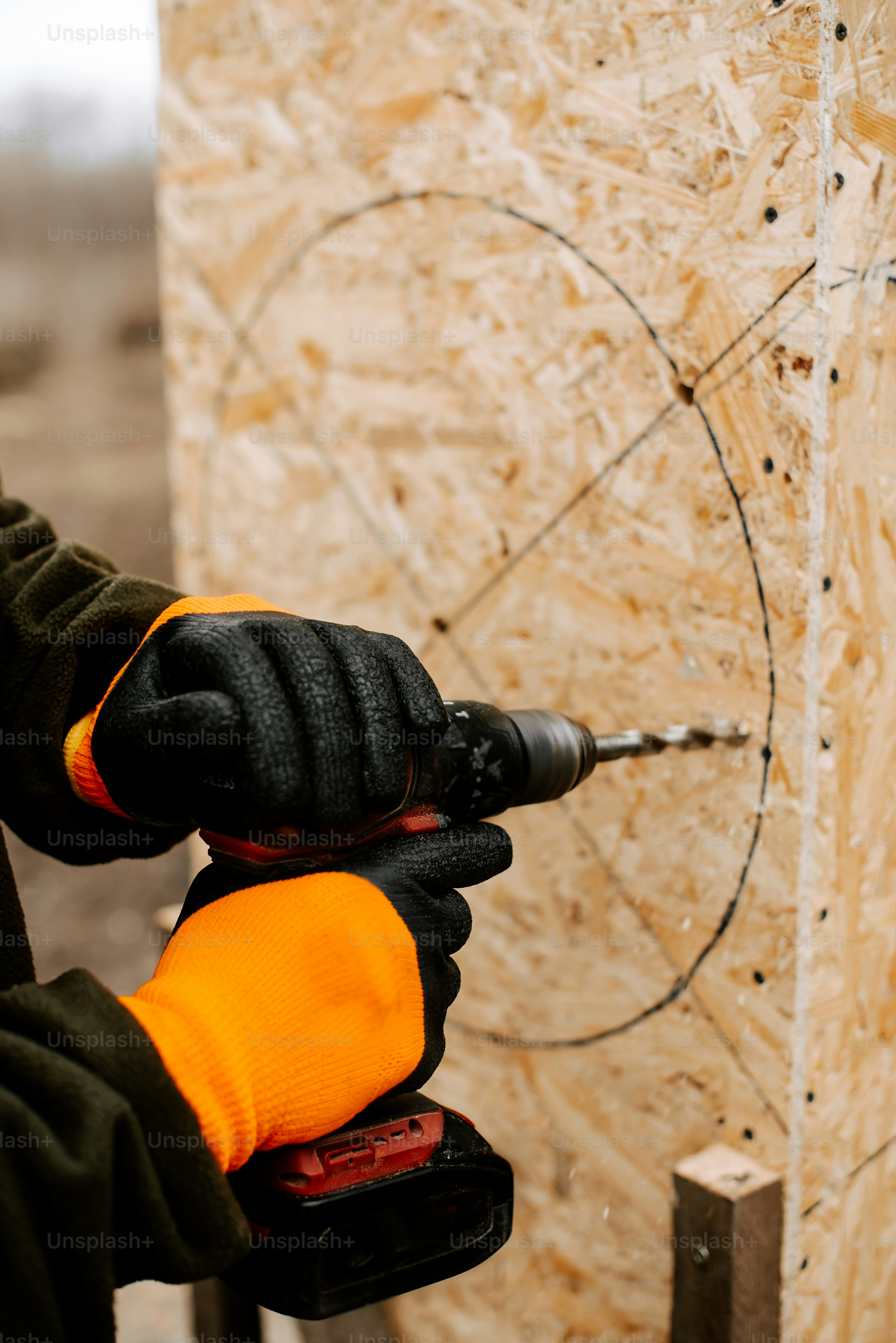 A person using a drill gun on a piece of wood photo – Project Image on ...