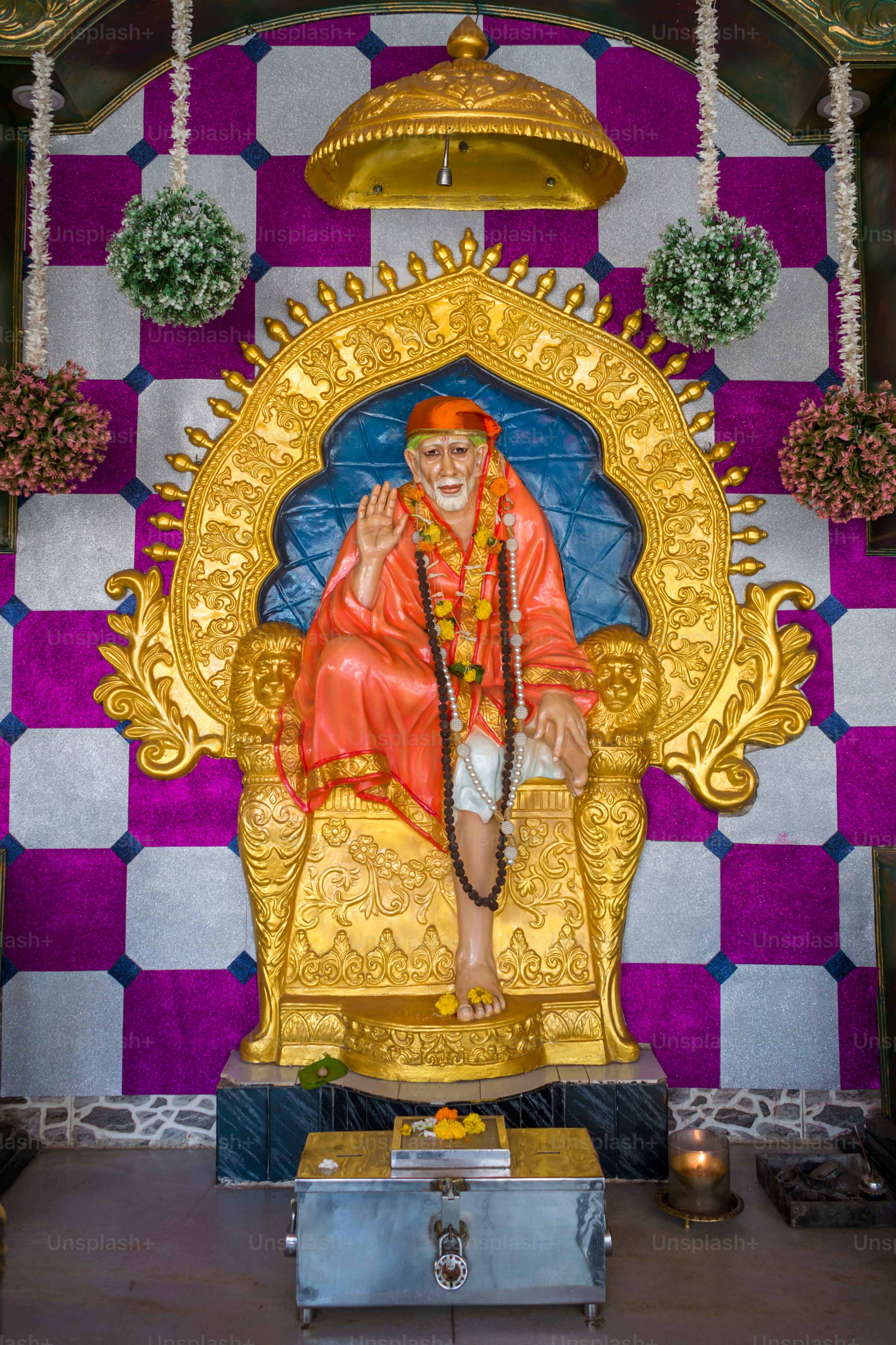 A statue of a man sitting on a golden throne photo – Sai baba Image on ...
