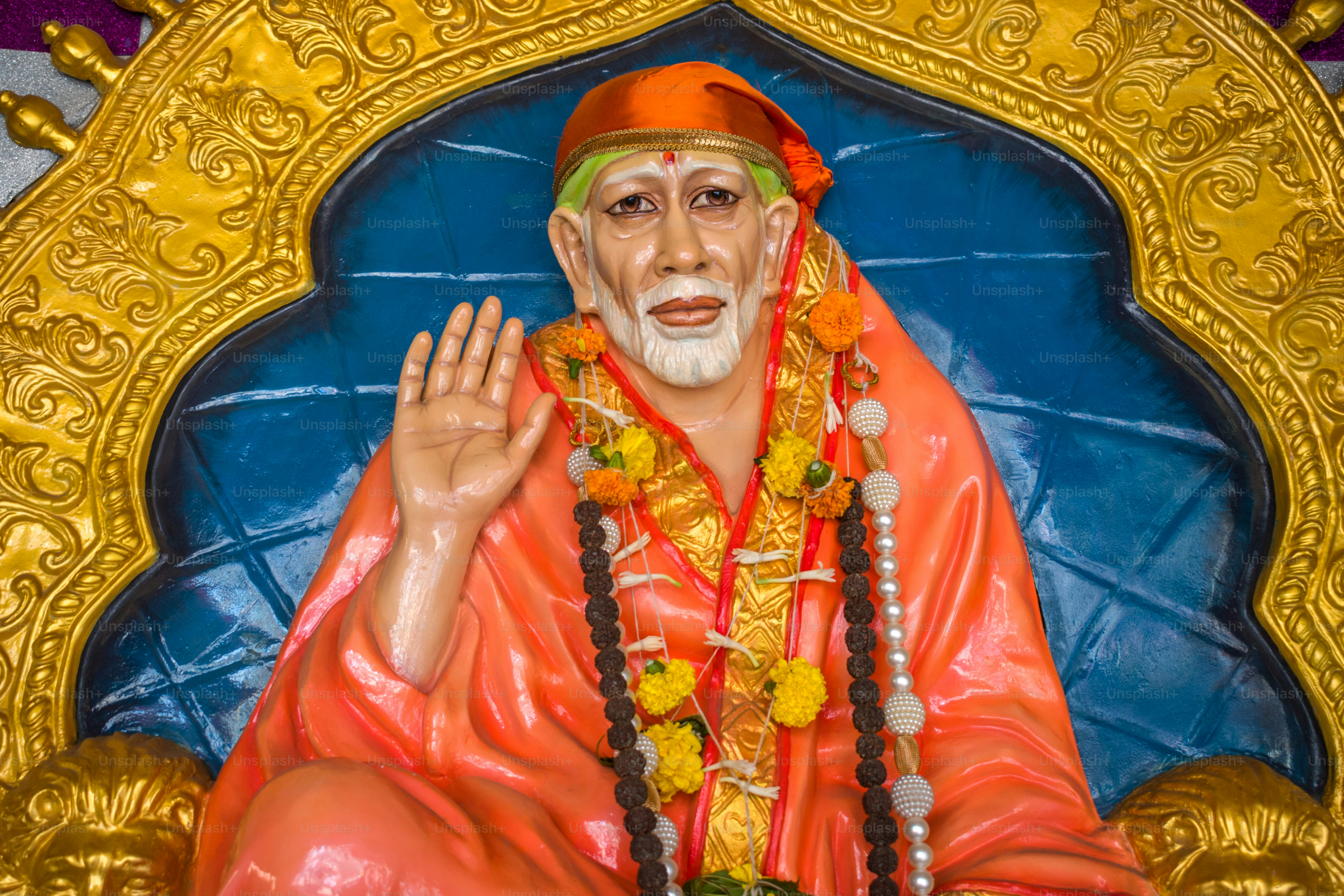 A statue of a man sitting on a golden throne photo – Sai baba Image on ...