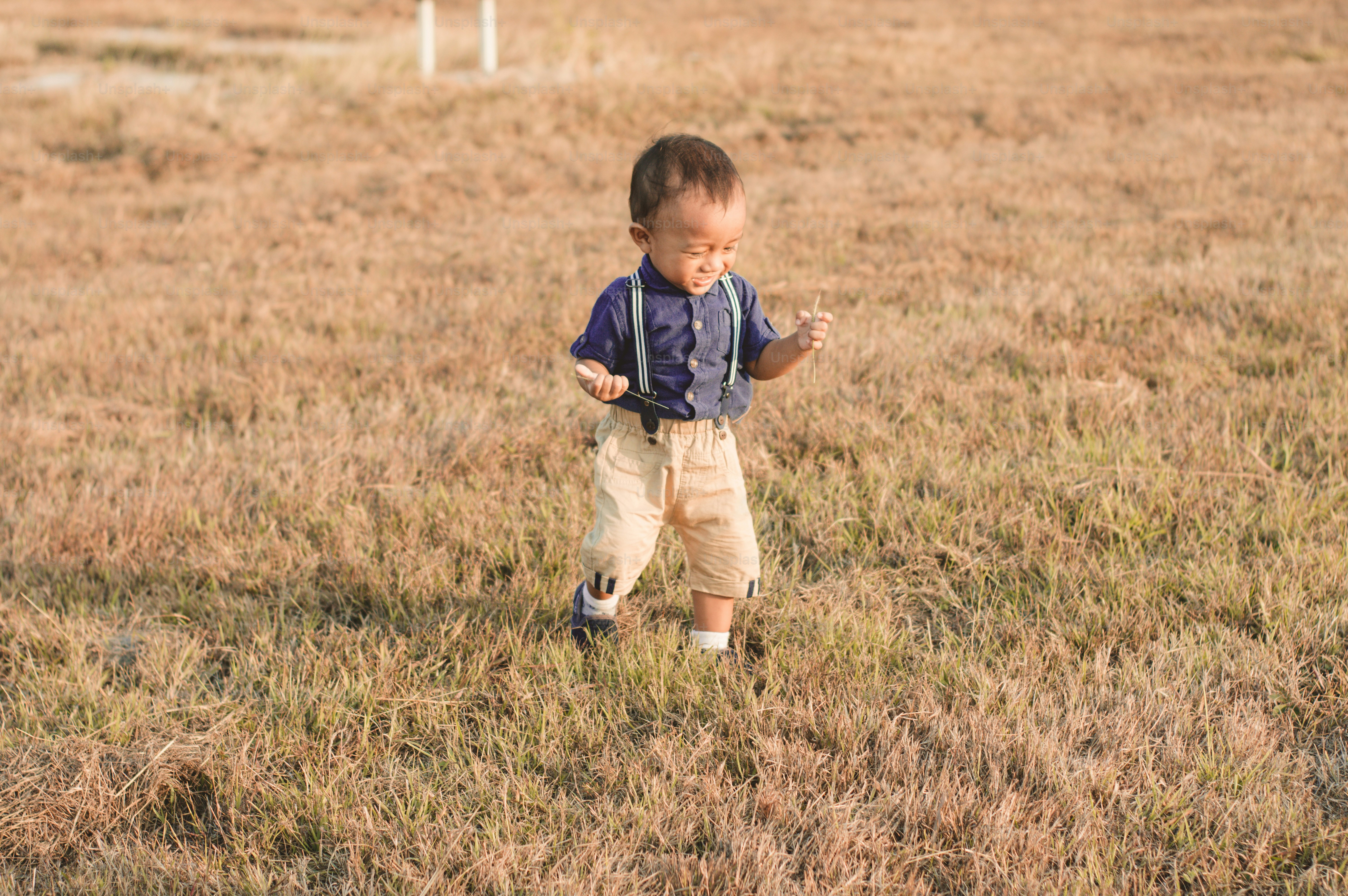 A little boy that is standing in the grass photo – West java Image on ...