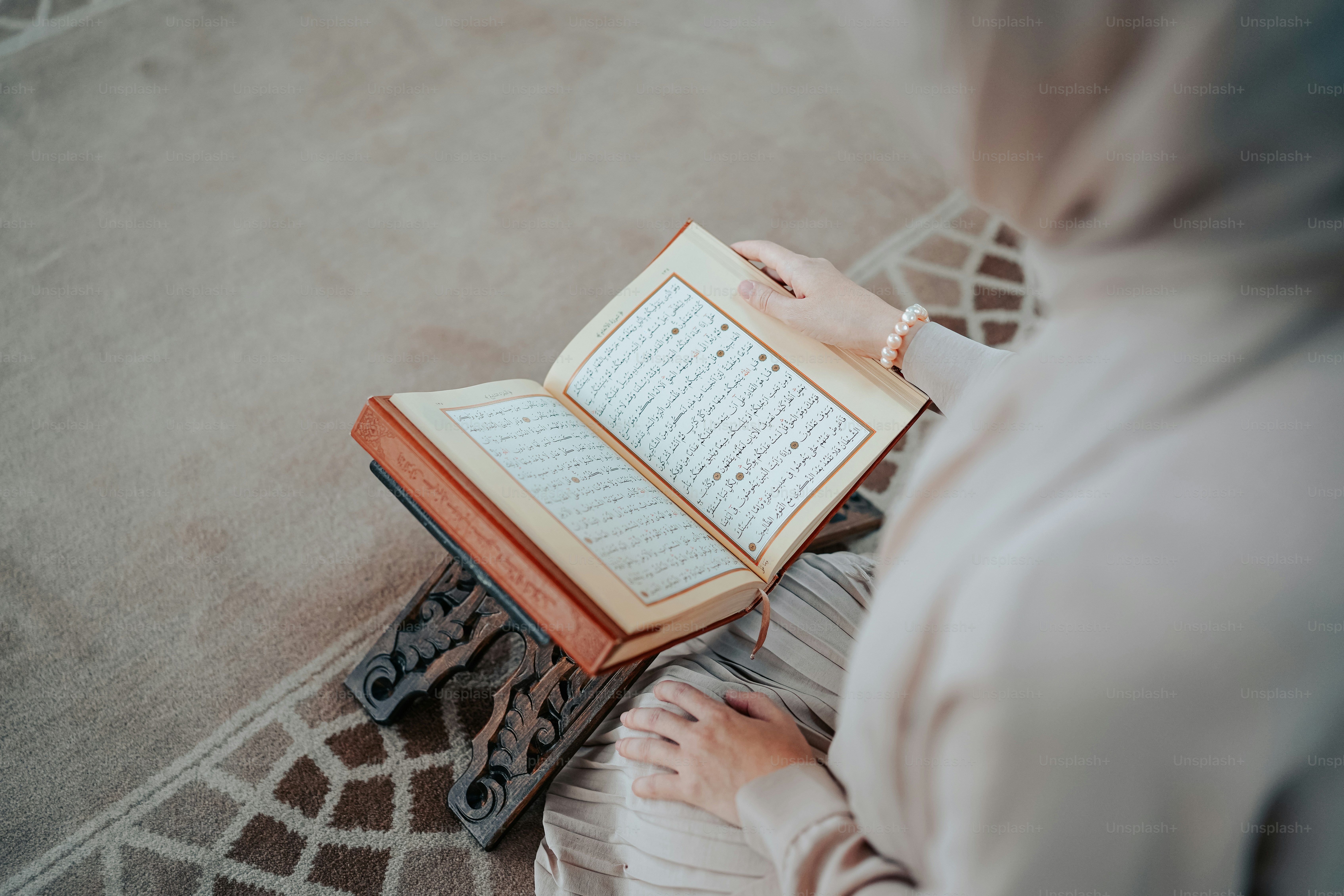 A woman sitting on the floor reading a book photo – Salah Image on Unsplash